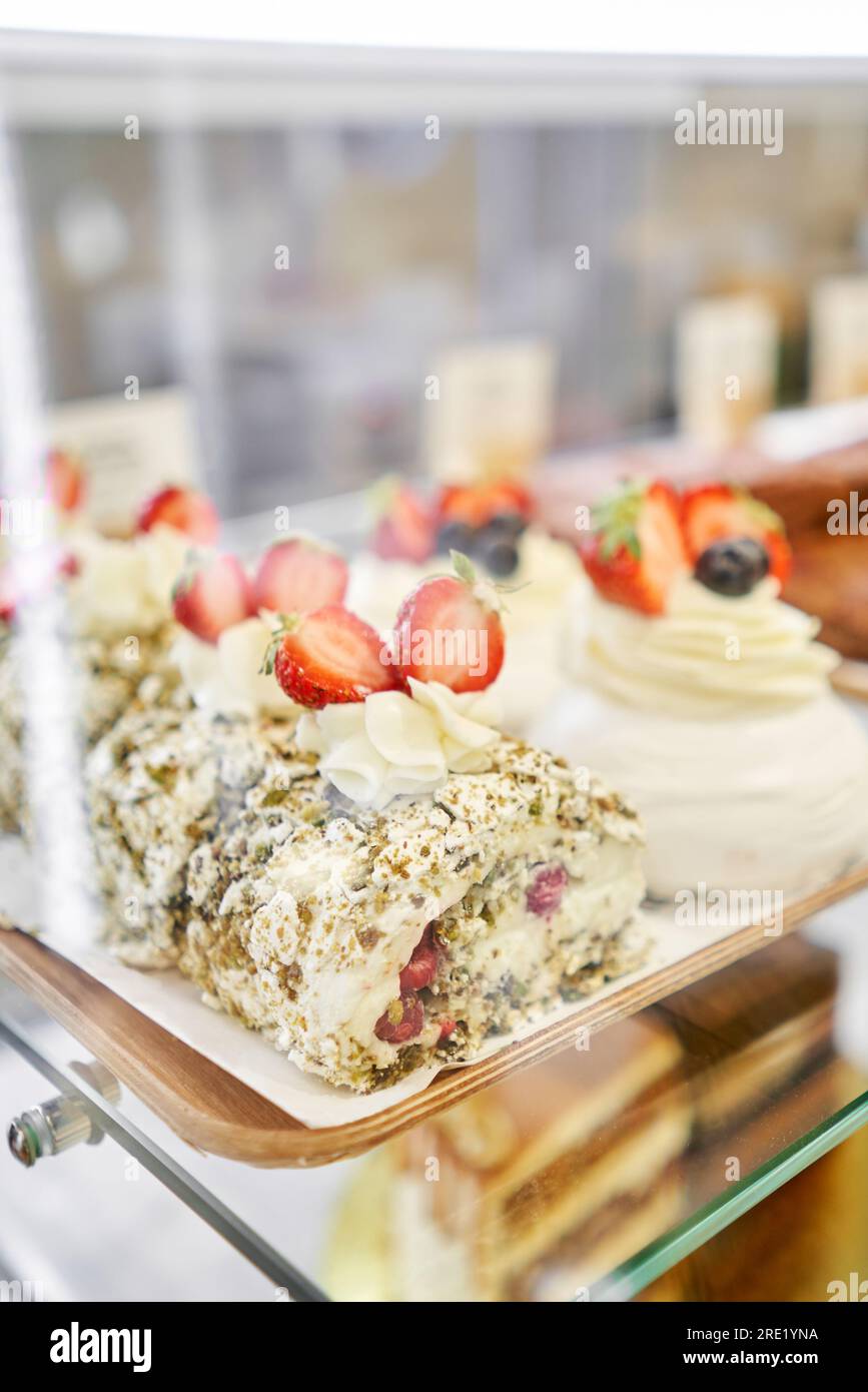 A variety of fresh pastries in the bakery window. almond croissant is ...