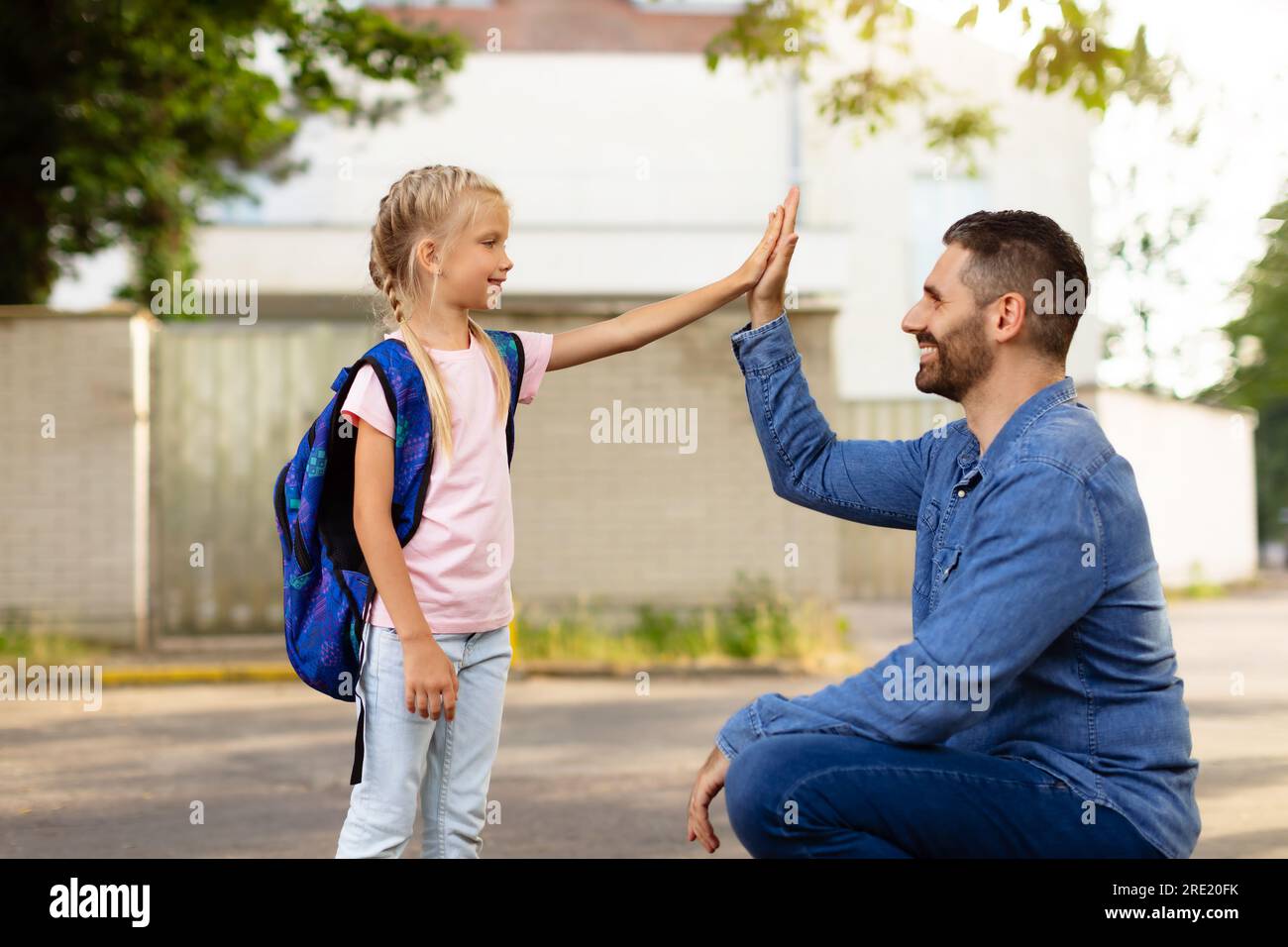 Father-daughter bonding. Parent and pupil of primary school giving high ...