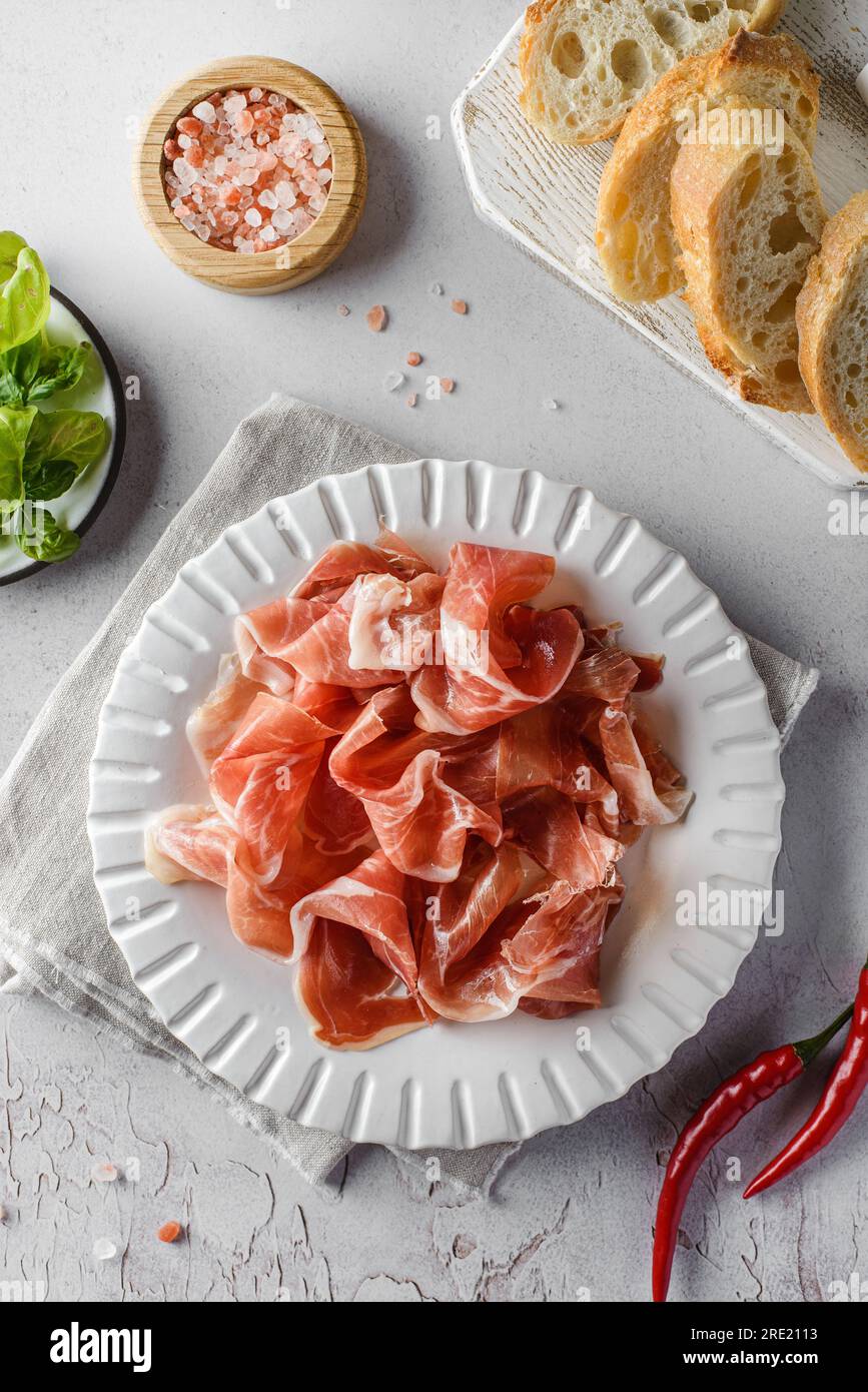 jamon on a light plate Stock Photo - Alamy