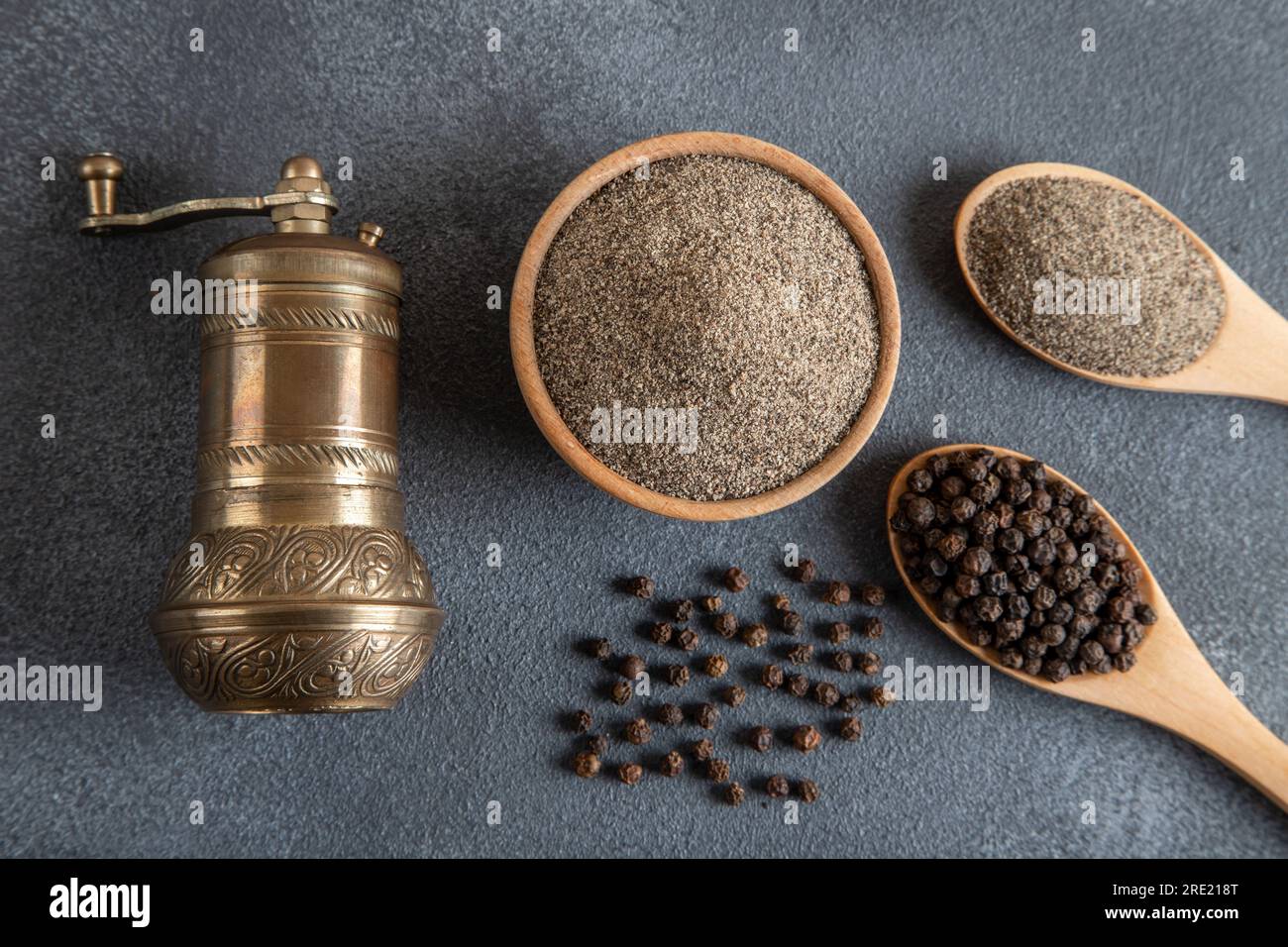 Black pepper grains, ground black pepper and metal mill ,top view Stock ...