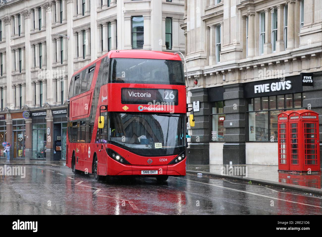 A RED STAGECOACH LONDON BUS AT ST. PAULS WITH RED LONDON TELEPHONE ...