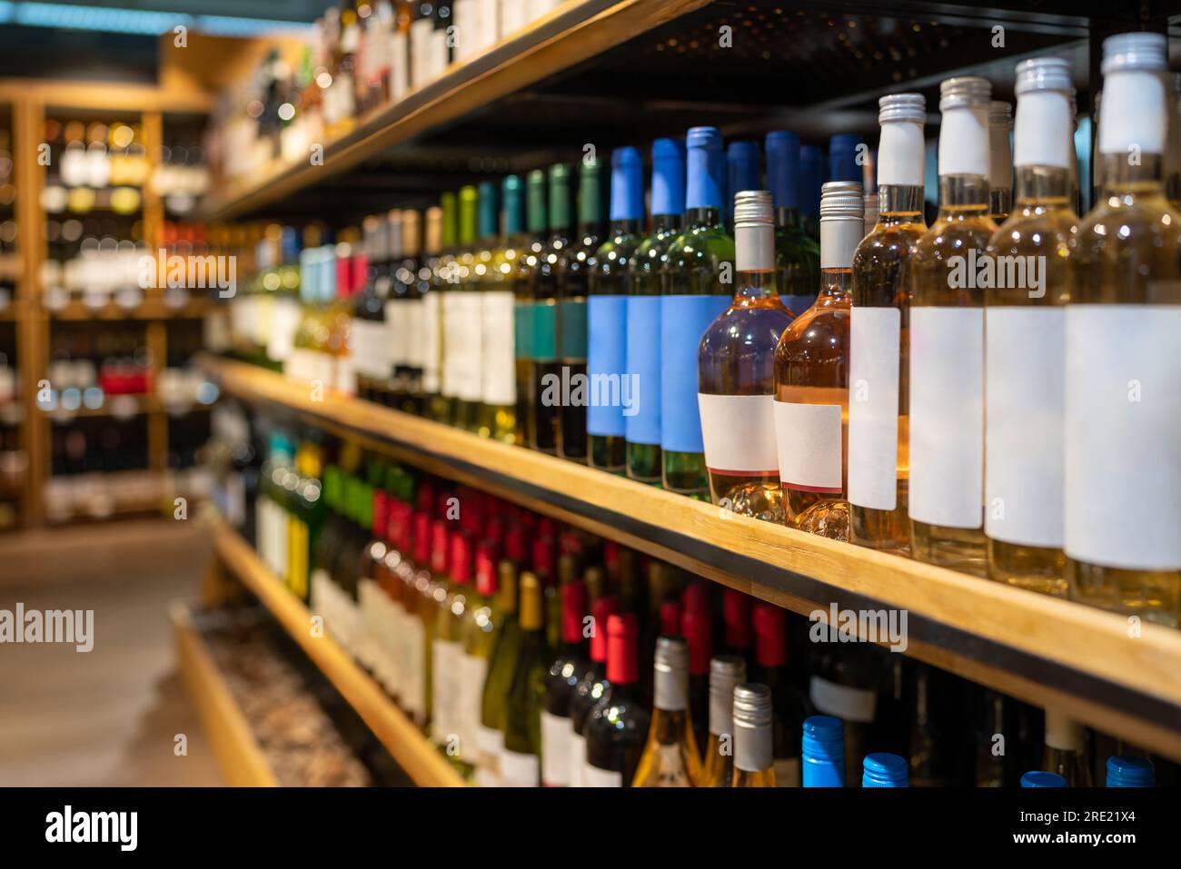 Alcohol business concept, wine bottles in a row on the shelf of wine ...