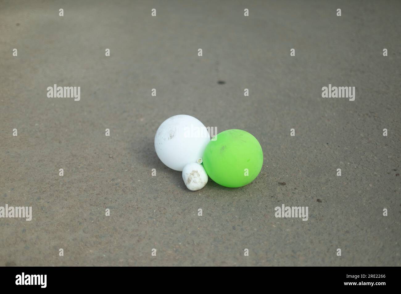 Balloon on asphalt. Remnants of holiday. Deflated siz ball. Abandoned ...