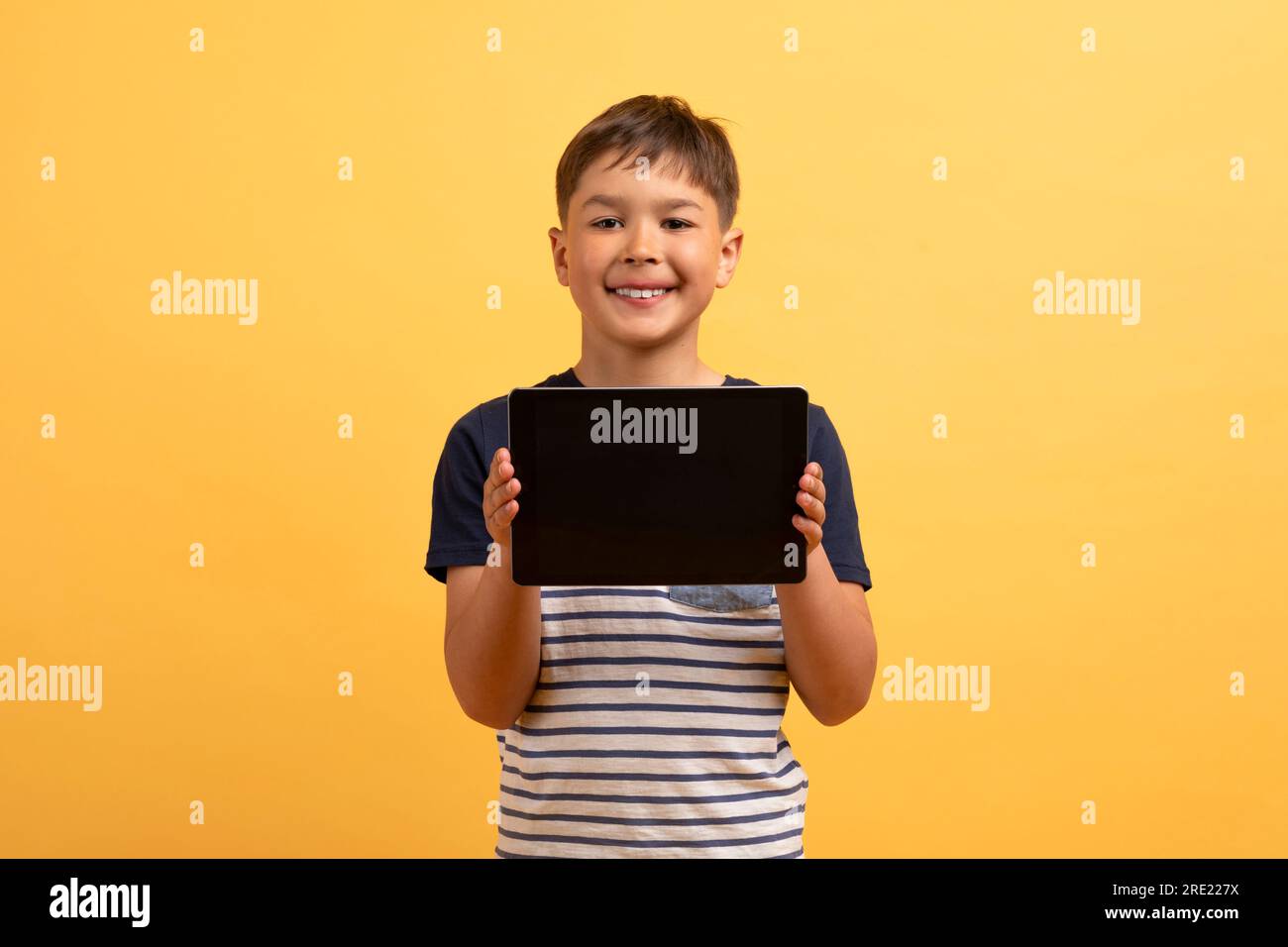 Cute kid holding digital tablet with black empty screen Stock Photo - Alamy