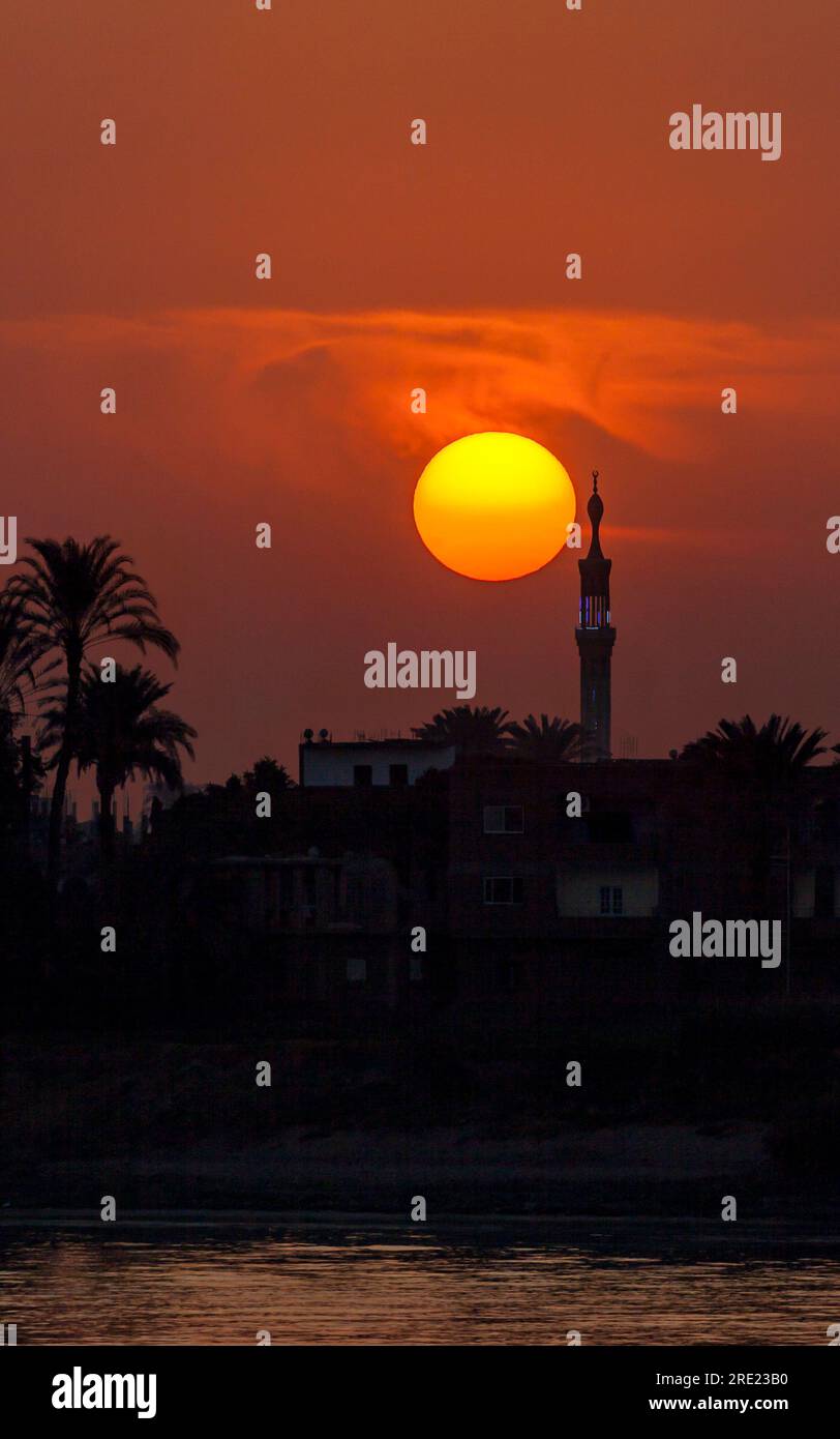 Sun setting behind minaret on the Nile Stock Photo - Alamy