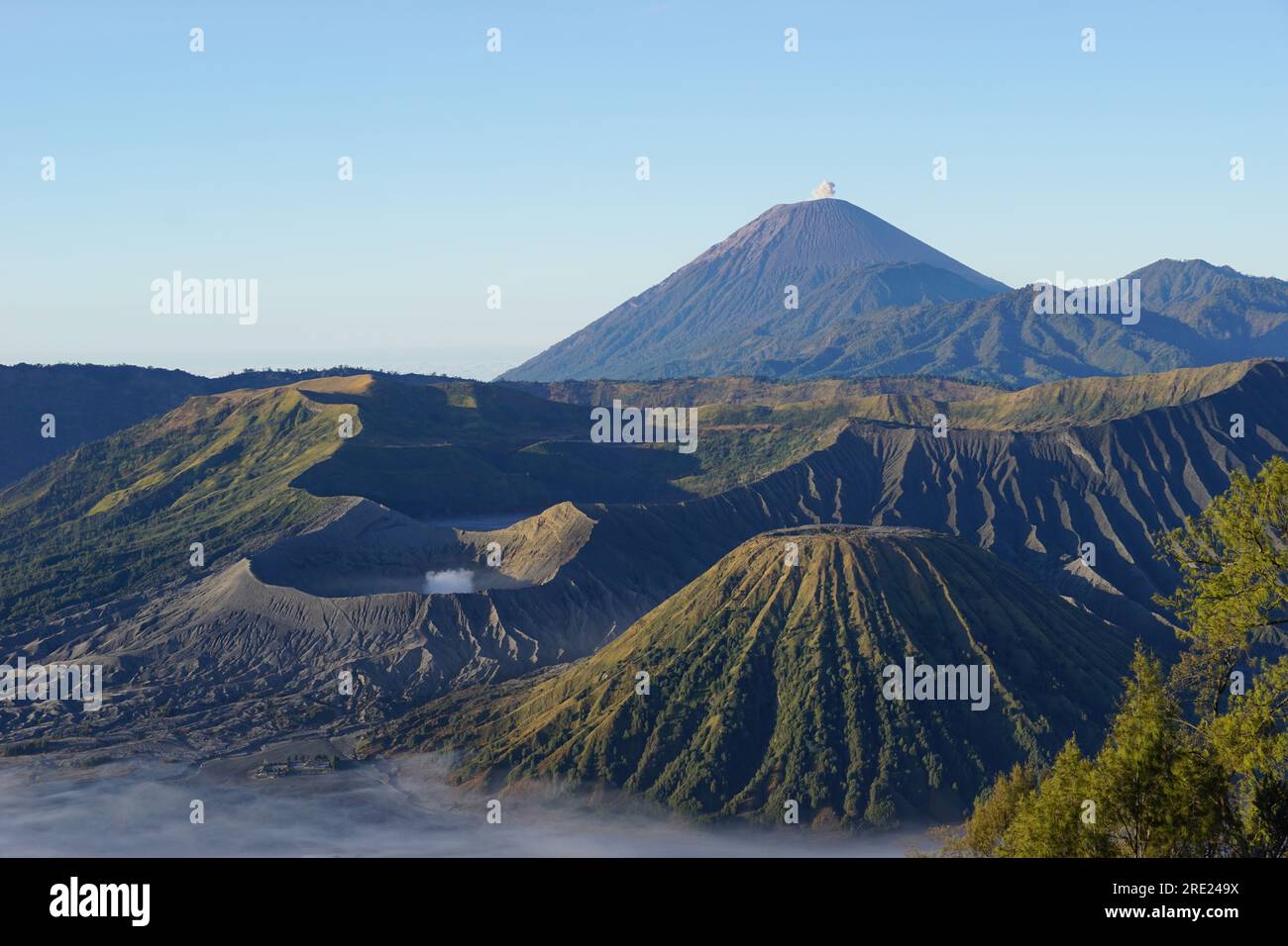 The plateau of Mount Bromo and smoking Mount Semeru in Java Stock Photo ...