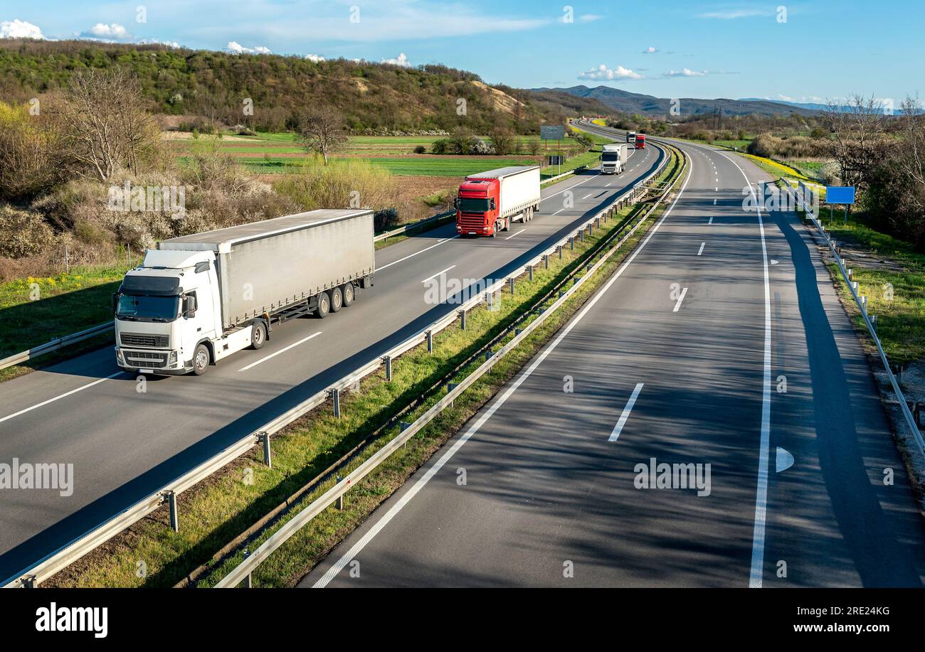 Highway transport. Transportation Trucks in lines passing on a rural ...