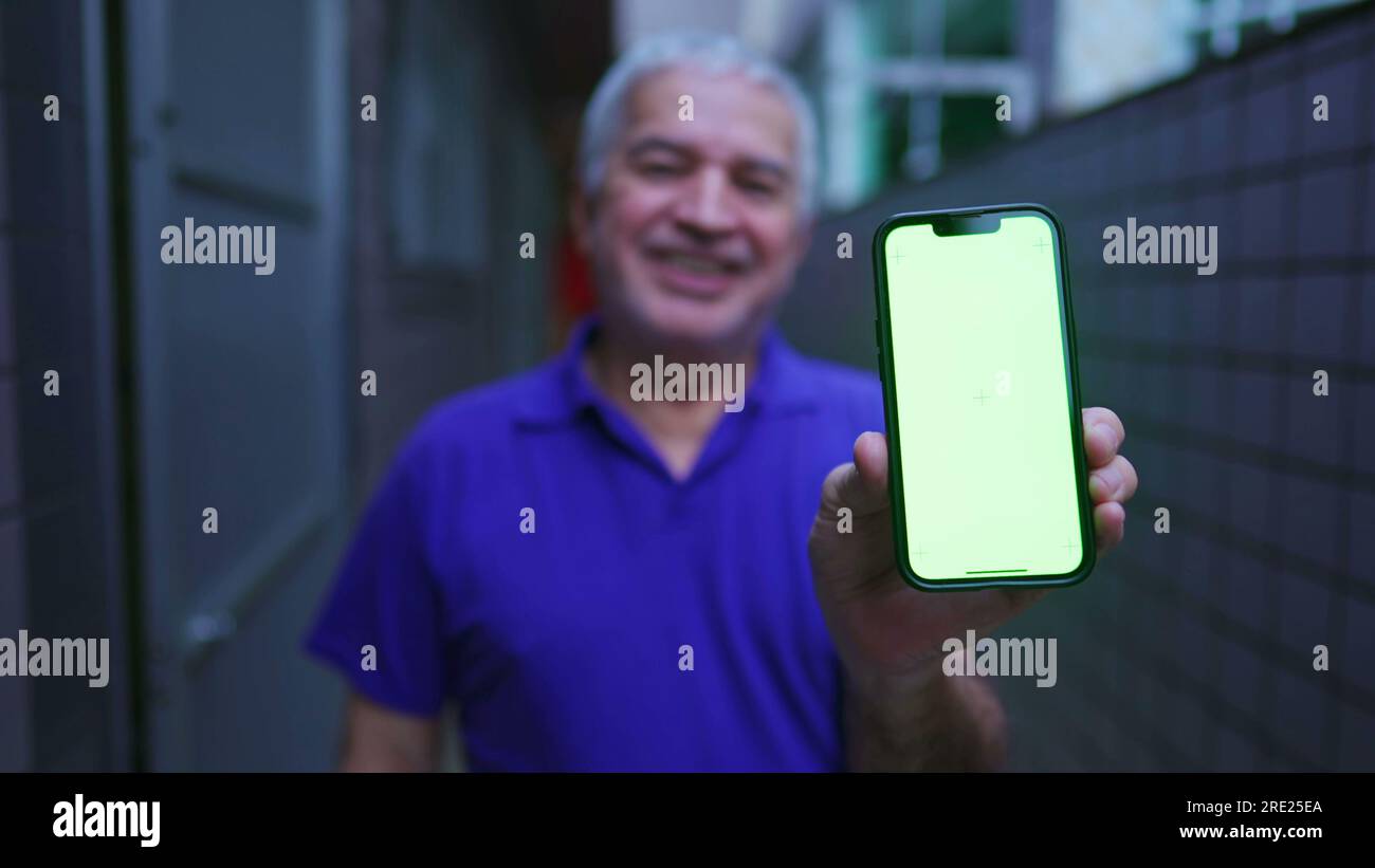 Happy Blurred Senior Man Presenting Smartphone with Chroma Key ...