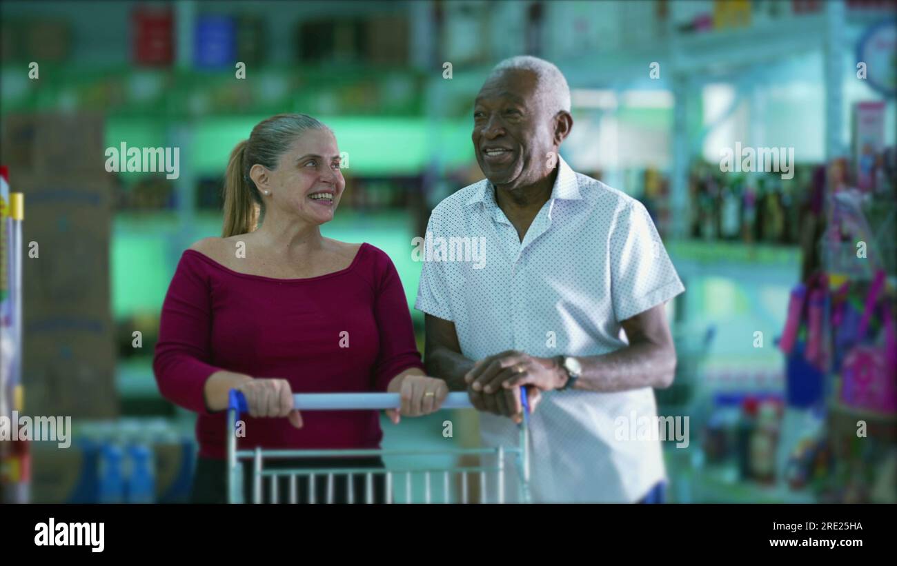 Happy diverse customers smiling inside grocery business store with ...