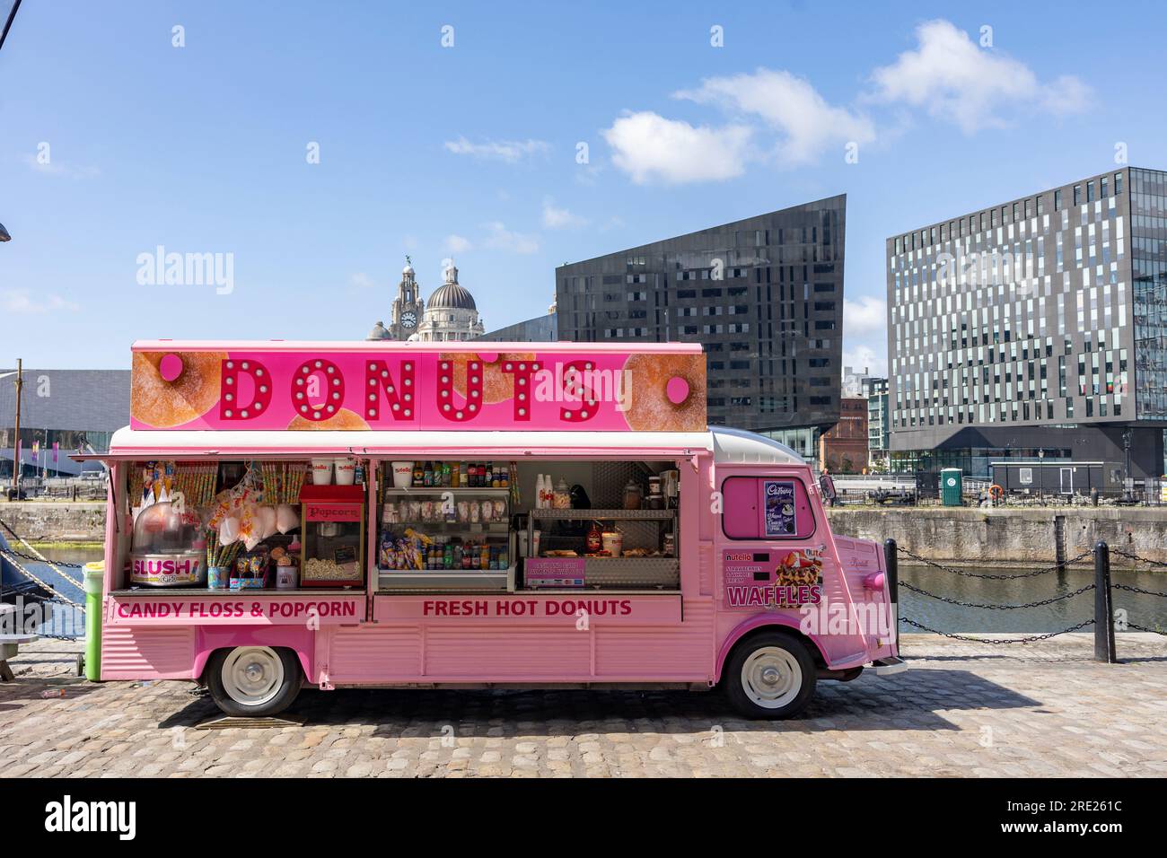 Liverpool, united kingdom May, 16, 2023 Pink food truck offering donuts ...