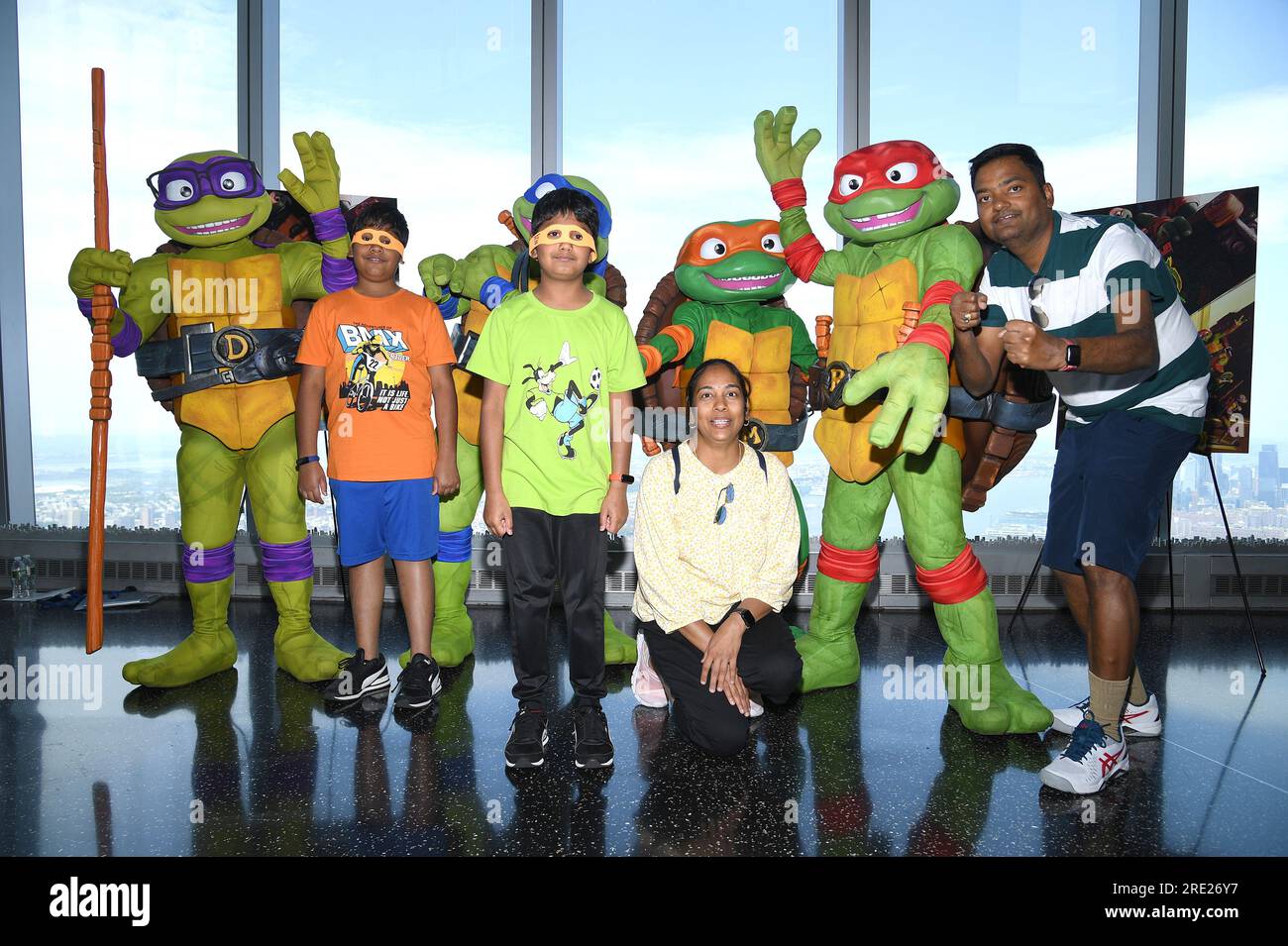 New York, USA. 24th July, 2023. Visitors pose with comic book and movie ...