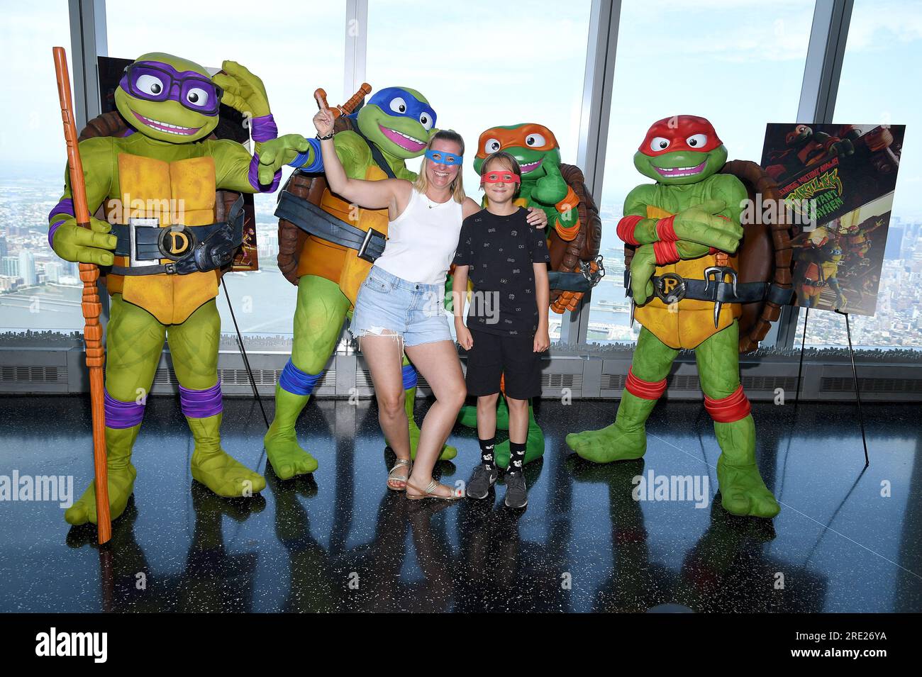 New York, USA. 24th July, 2023. Visitors pose with comic book and movie ...