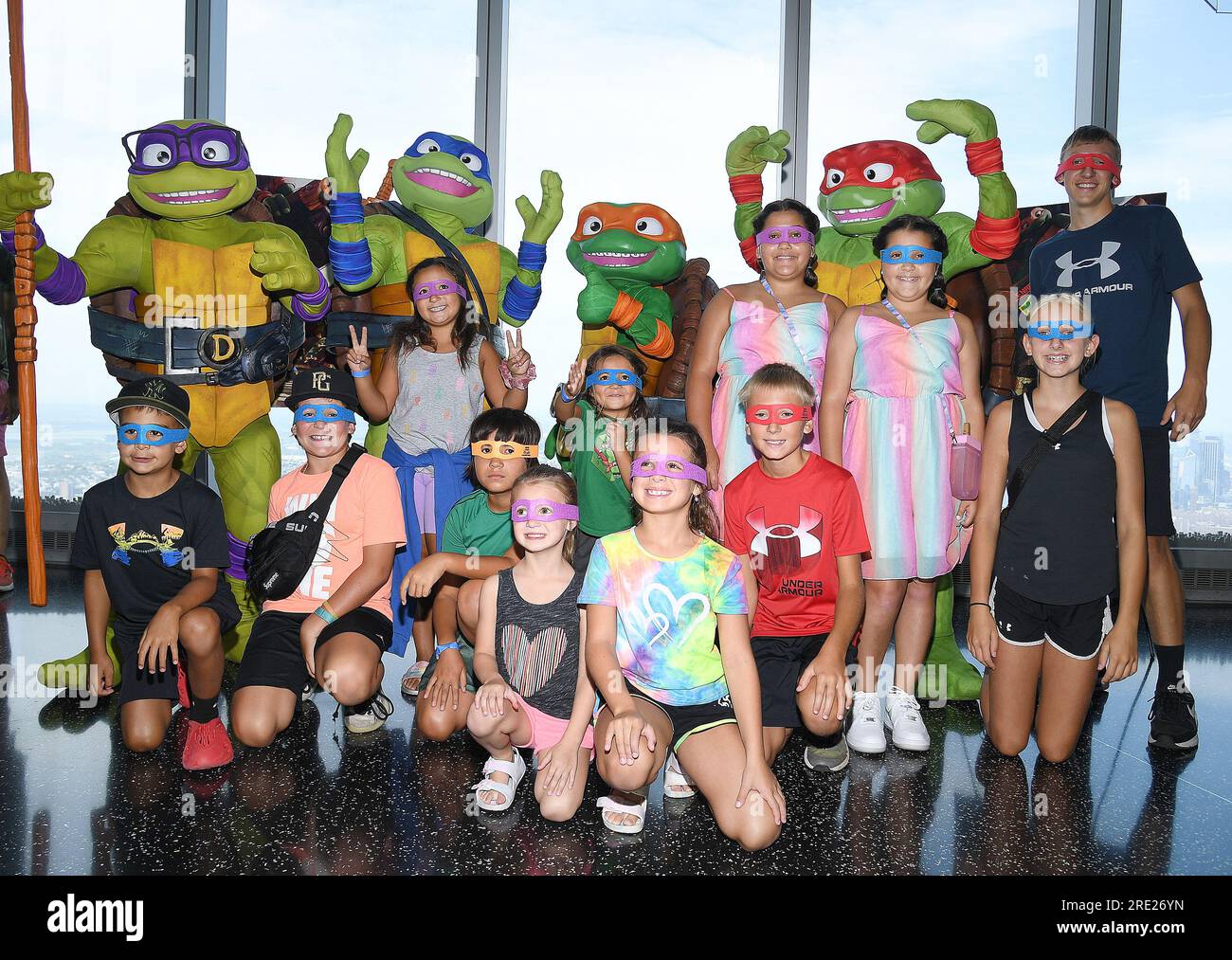 New York, USA. 24th July, 2023. Visitors pose with comic book and movie ...