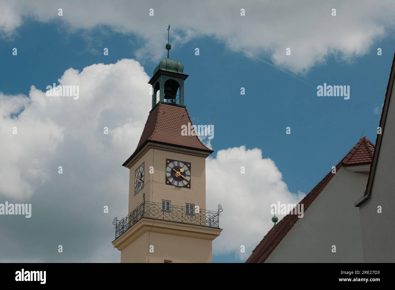 A stately German clock tower reaching into a dramatic cloudy sky ...