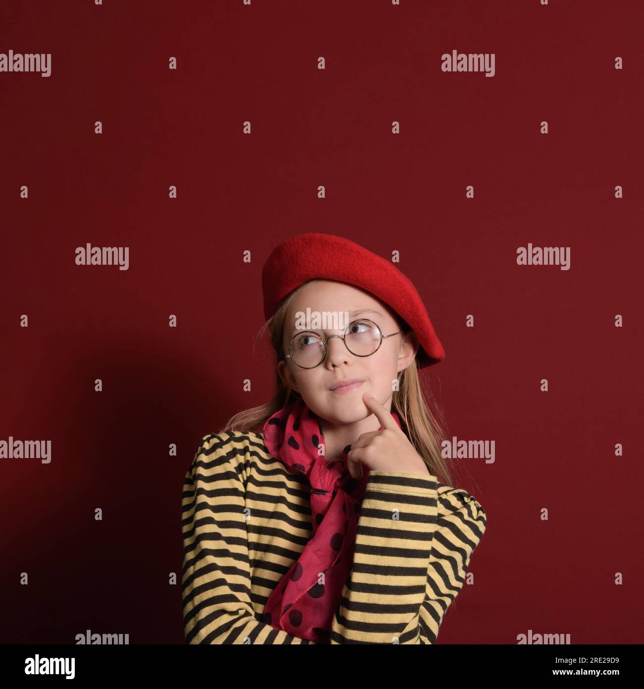 Just imagine. Portrait of a girl wearing a red beret, a red bow, and a ...