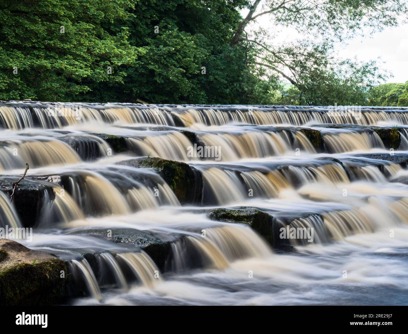 A beautiful weir across the river Wharfe at Burley-in-wharfedale in ...