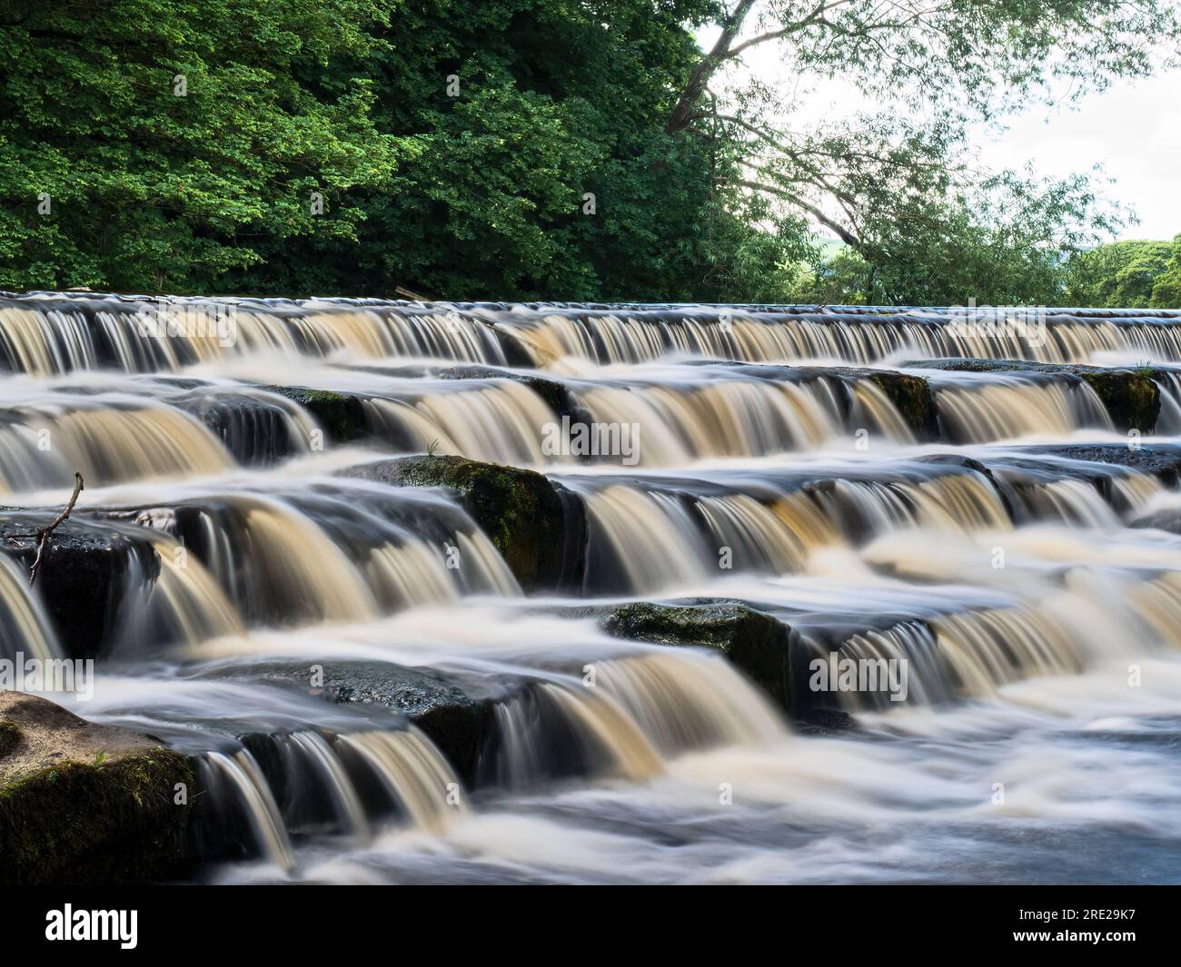 A beautiful weir across the river Wharfe at Burley-in-wharfedale in ...
