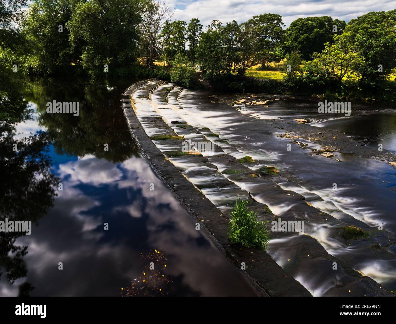 A beautiful weir across the river Wharfe at Burley-in-wharfedale in ...