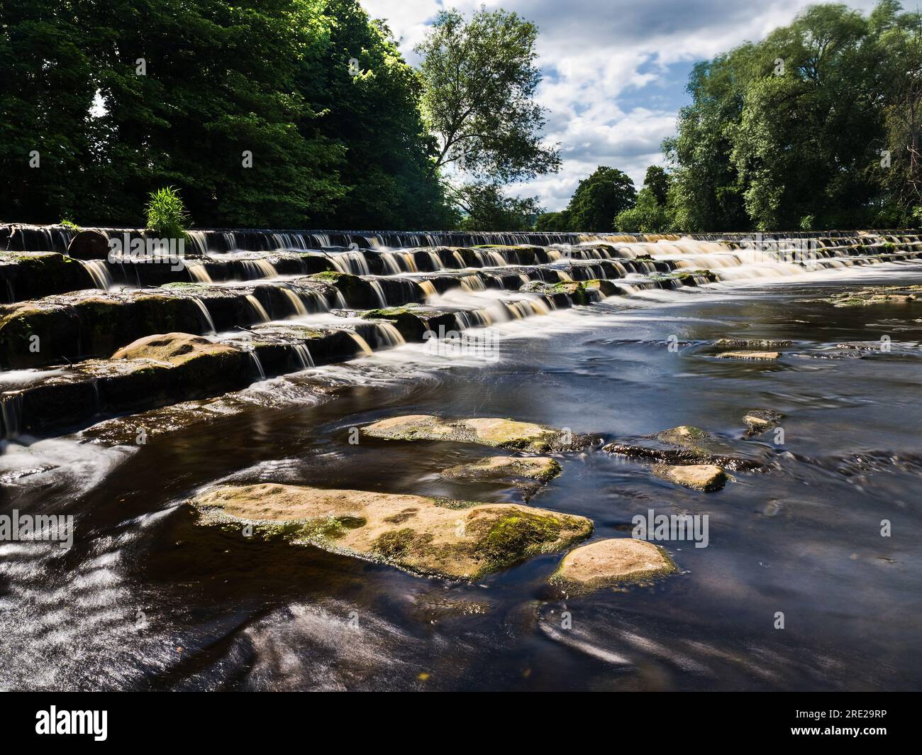 A beautiful weir across the river Wharfe at Burley-in-wharfedale in ...