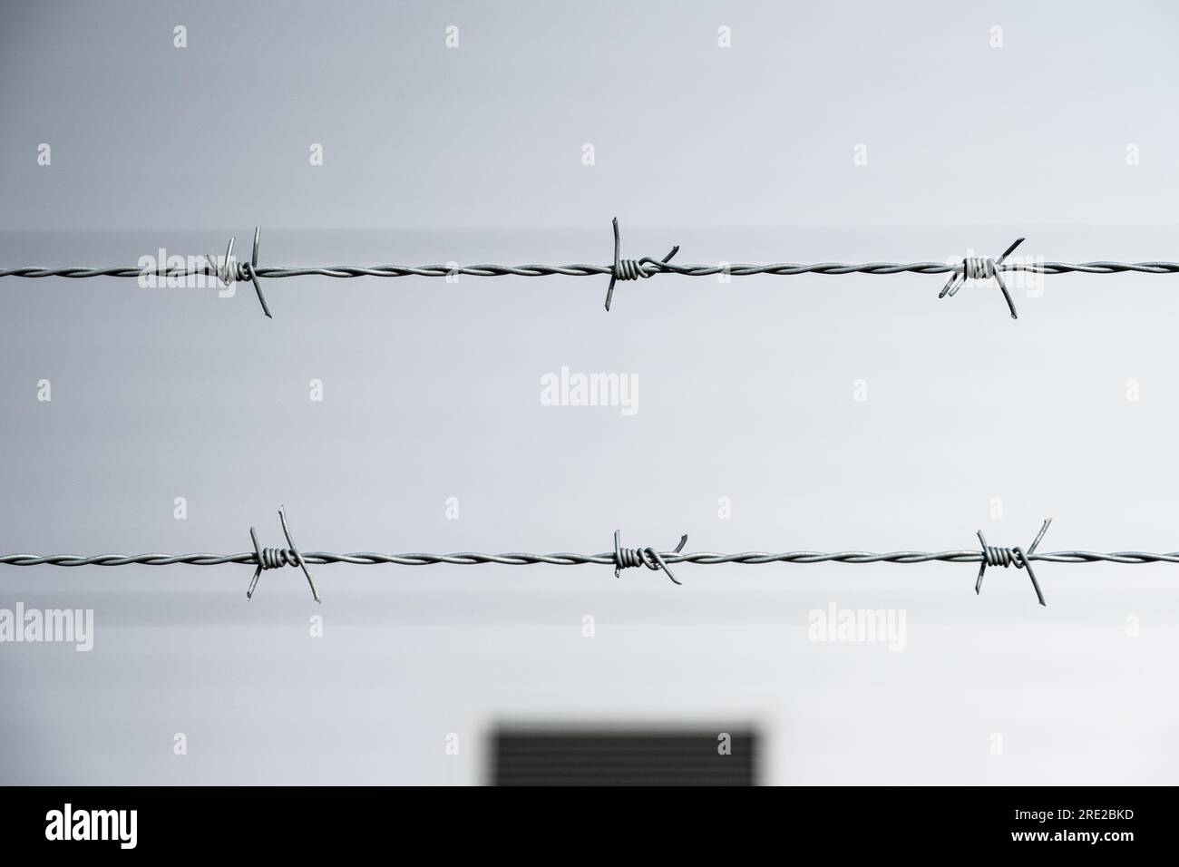 Barb wire securing a large warehouse Stock Photo - Alamy