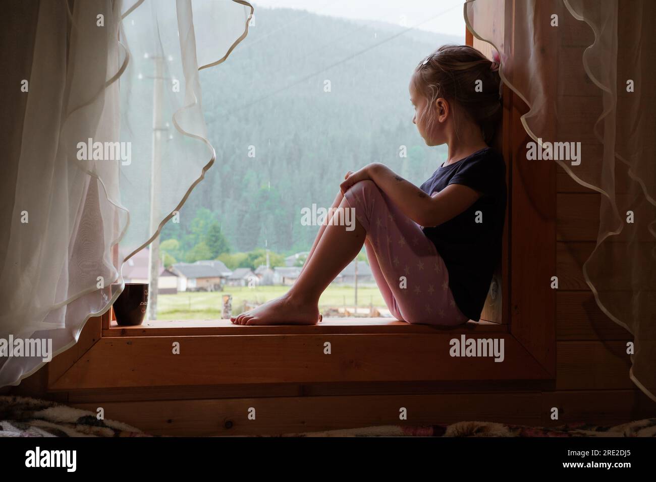 Kid indoor looking rain hi-res stock photography and images - Alamy