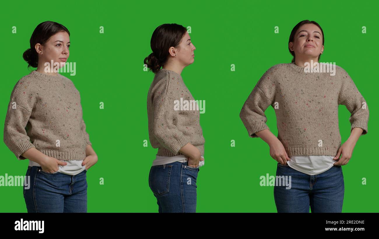 Close up of woman posing over greenscreen background, standing on green ...