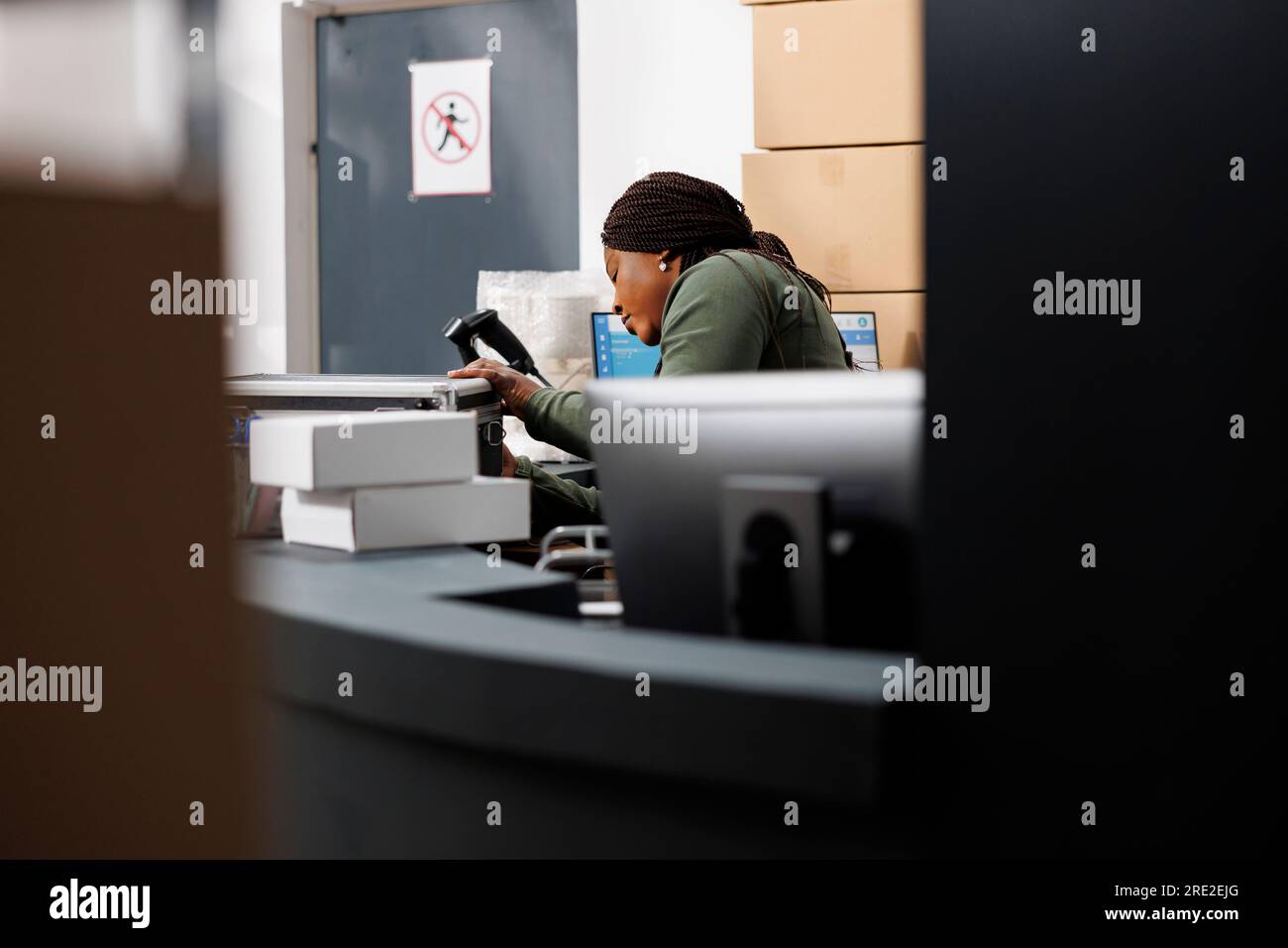 African american supervisor checking metallic box before shipping ...