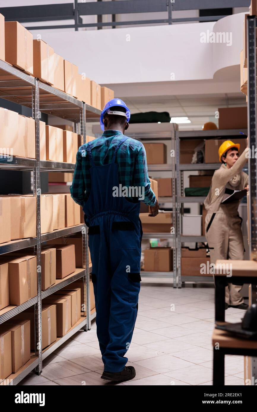 Warehouse loader carrying carton container in delivery service ...