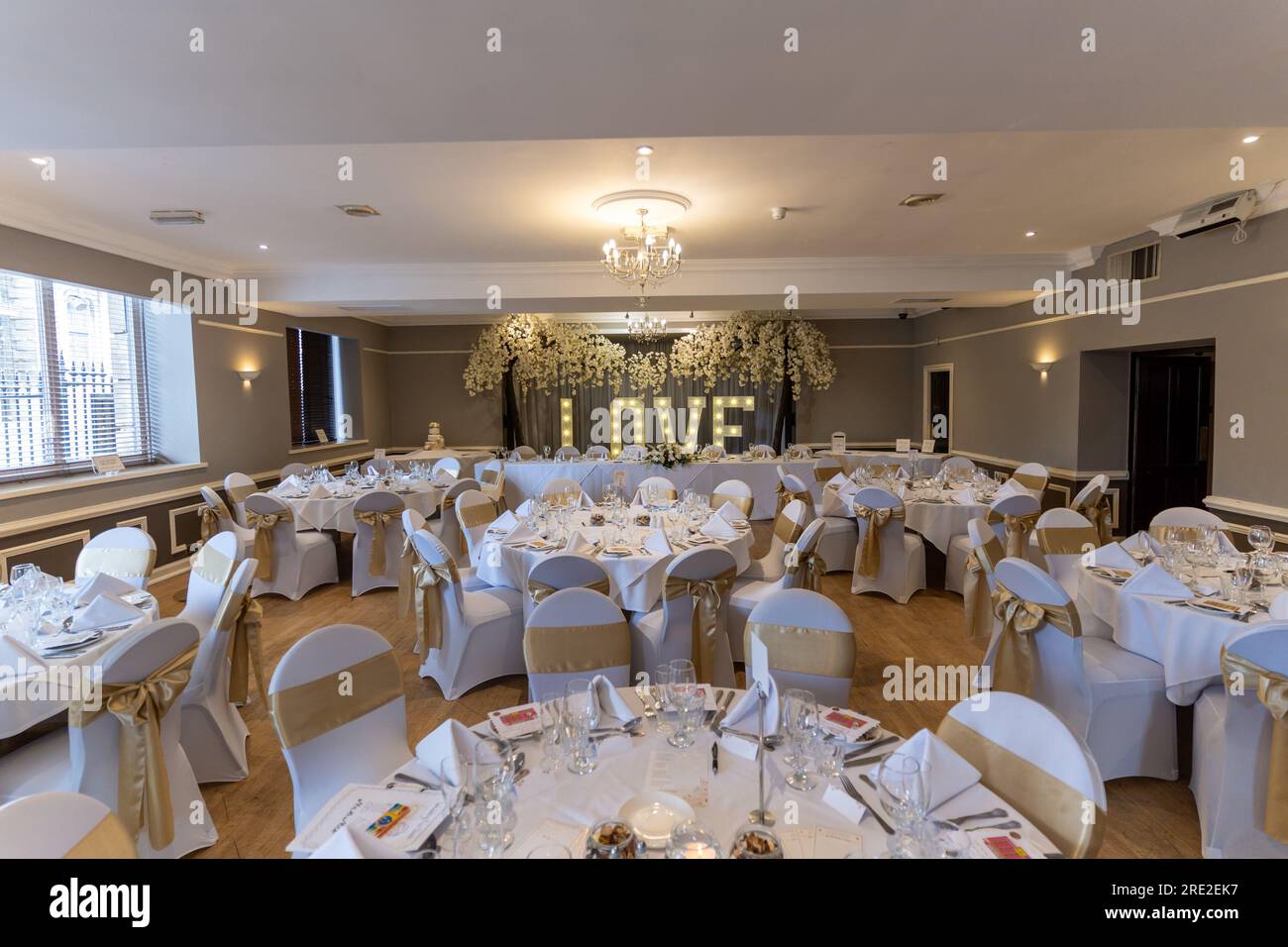 An empty wedding reception area set up with tables, ready for guests to ...