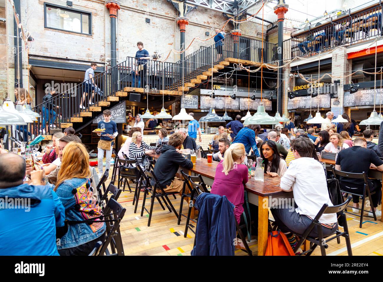 People eating in a food court, interior of Mackie Mayor inside a former ...