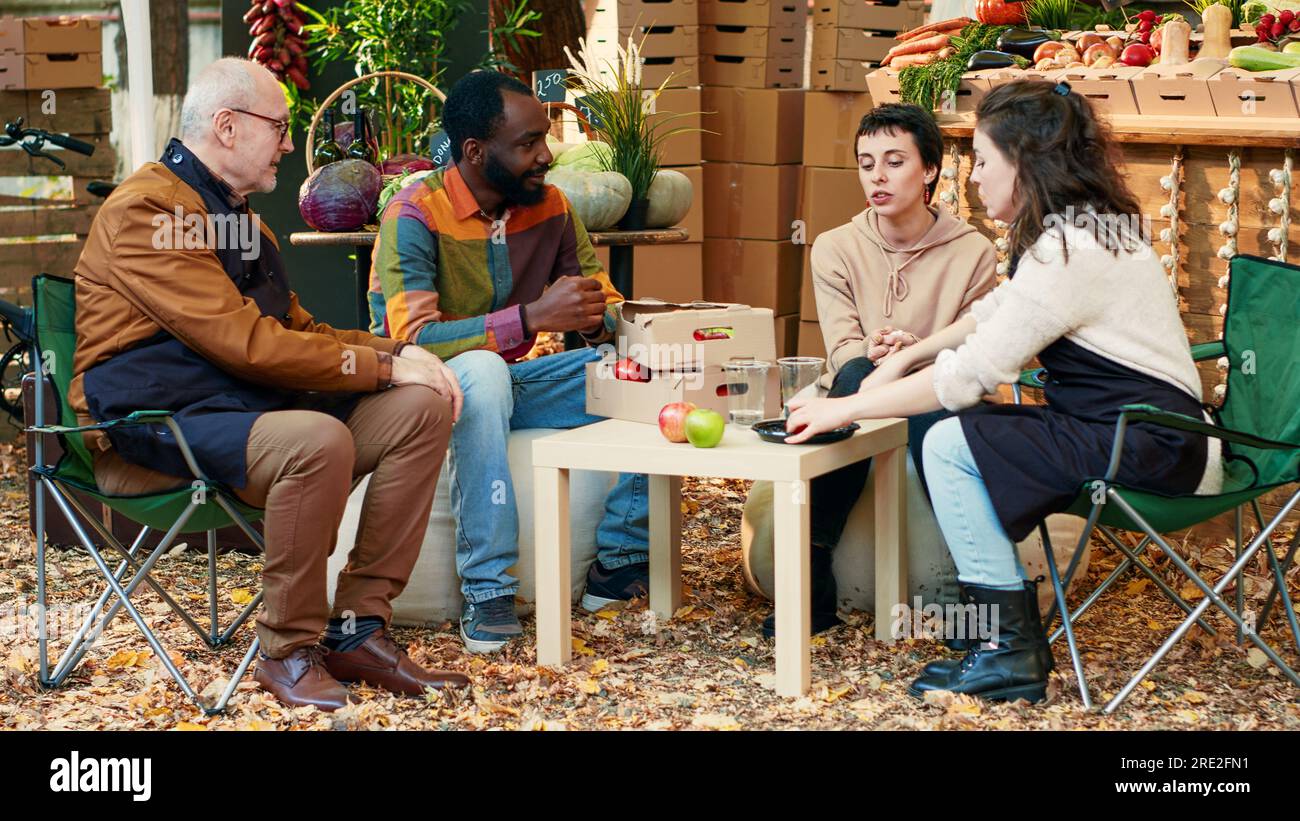 Happy group of friends doing product sampling at local food market ...