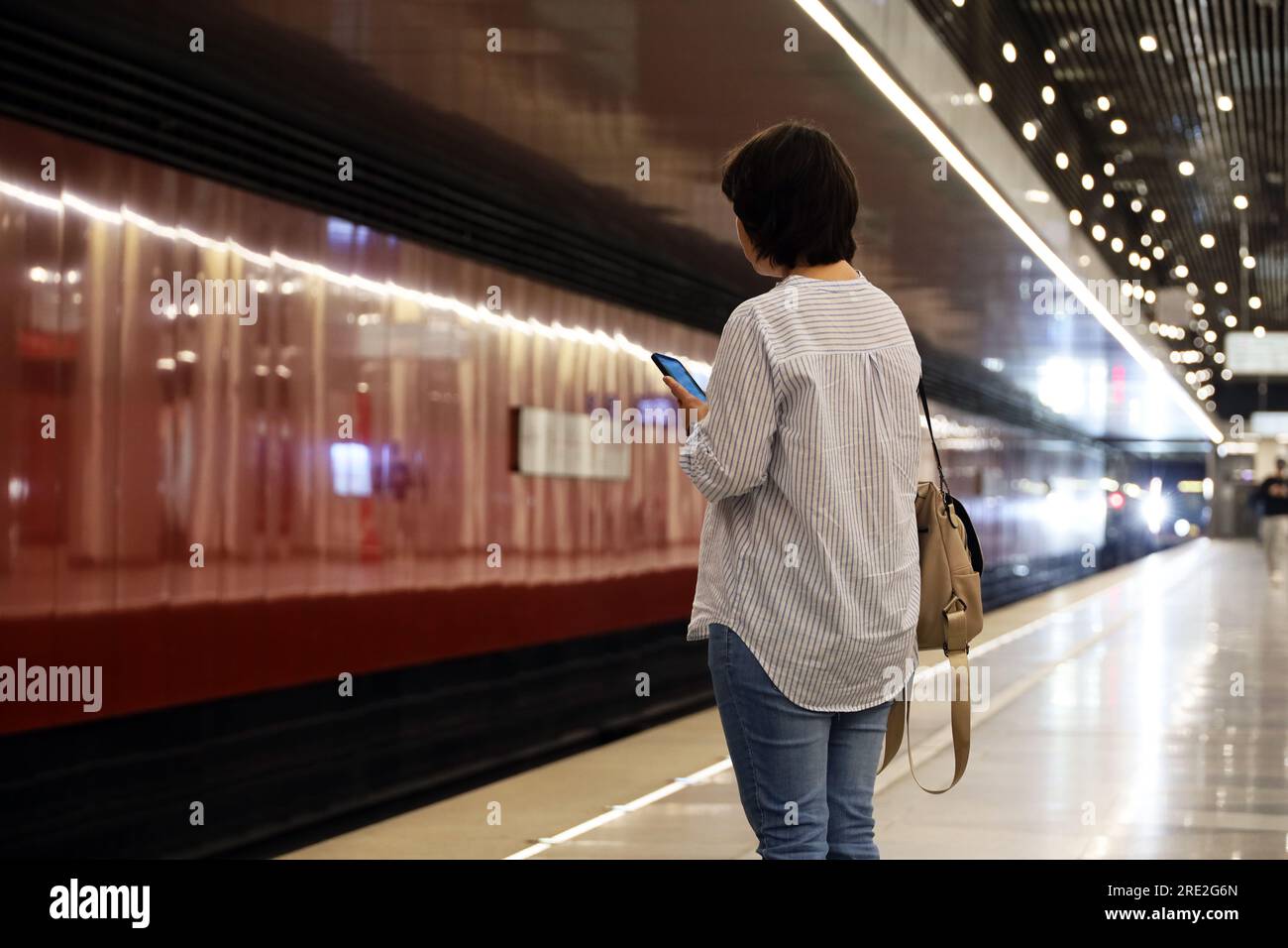 Young woman at metro station waiting for the train hi-res stock photography and images - Alamy