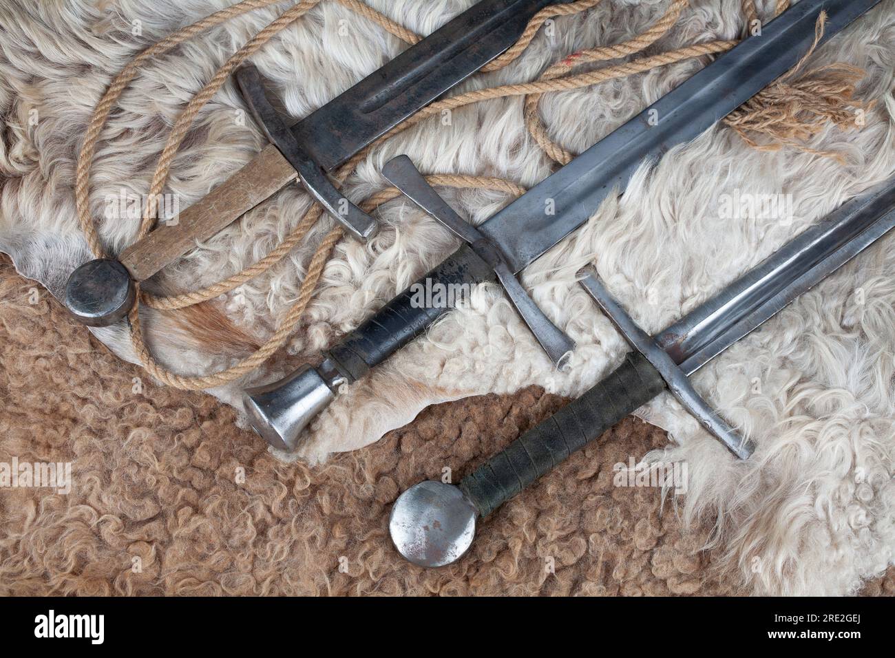 Medieval swords on sheep fur background Stock Photo - Alamy