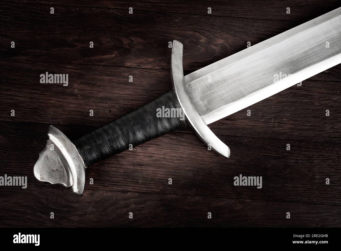 Medieval vintage sword on wooden backgrond Stock Photo - Alamy