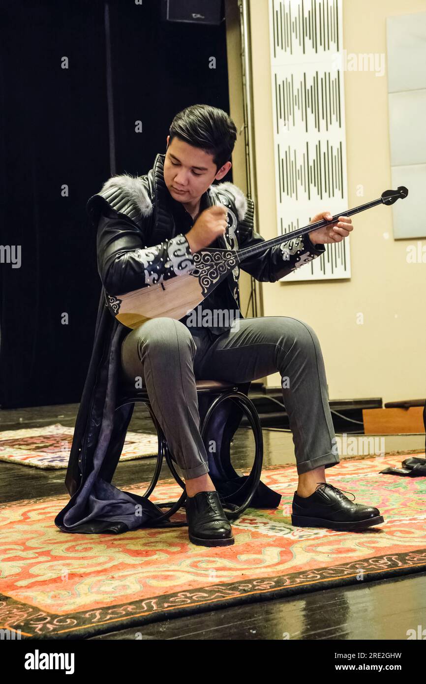 Kazakhstan, Almaty. Young Musician Playing the Dombra, a Traditional ...