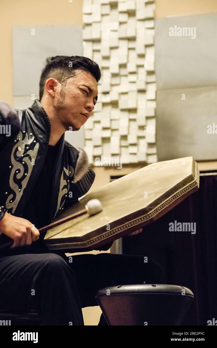 Kazakhstan, Almaty. Young Musician Playing the Dabyl, a Kazakh Drum ...