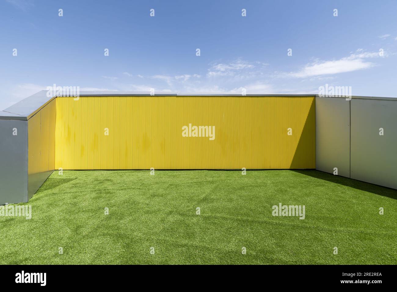 solarium terrace of a house with artificial grass floor and metal walls ...