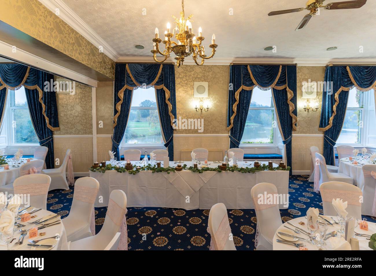 An empty wedding reception area set up with tables, ready for guests to ...