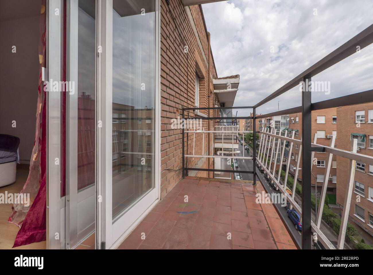 Small terrace of a house with a small square clay terrazzo floor, black ...
