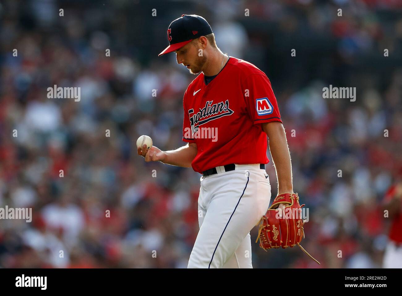Cleveland Guardians starting pitcher Tanner Bibee (61) inspects a ball ...