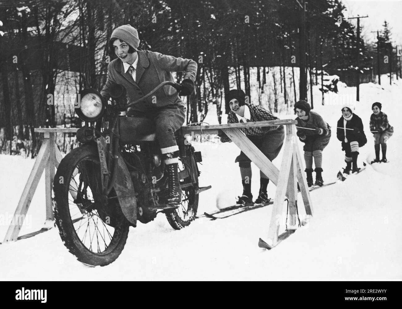 United States: C. 1937 A woman on a motorcycle equipped with outriggers ...