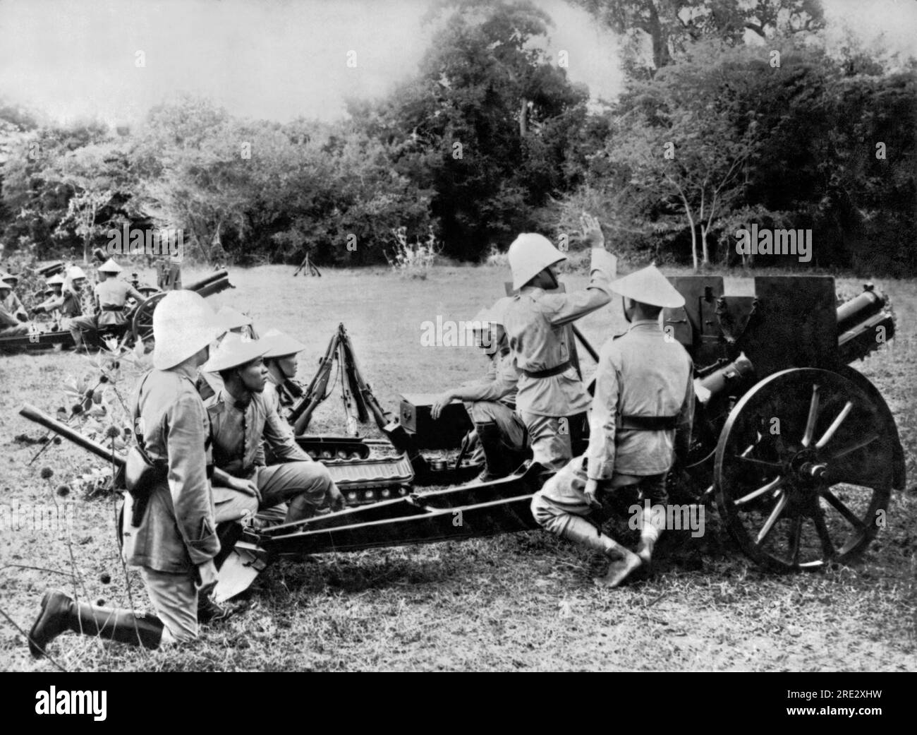 Indochina: c. 1910. French cannoniers instructing the Indochinese in ...