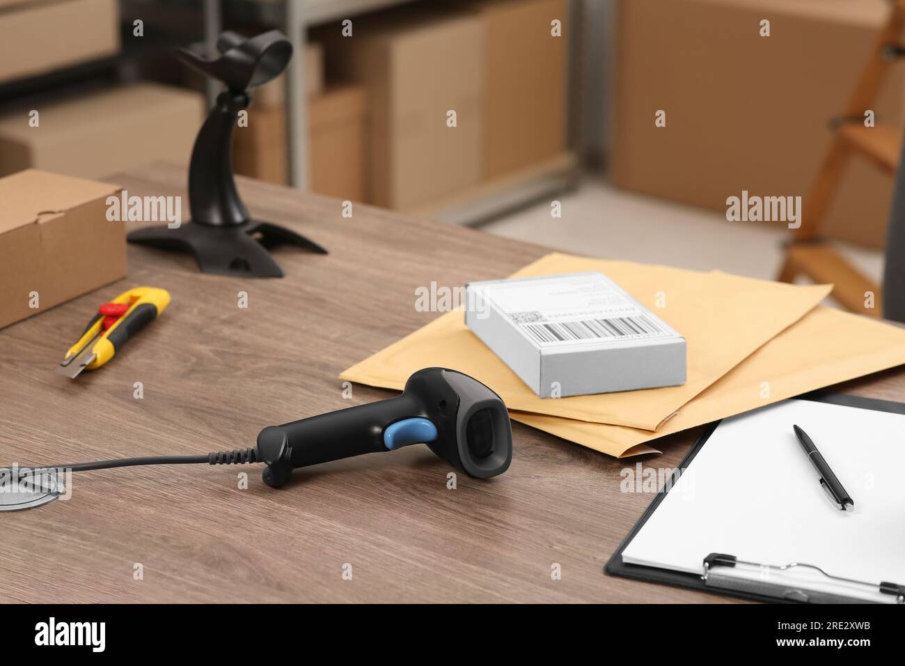 Black modern barcode scanner on wooden table in office. Online store ...