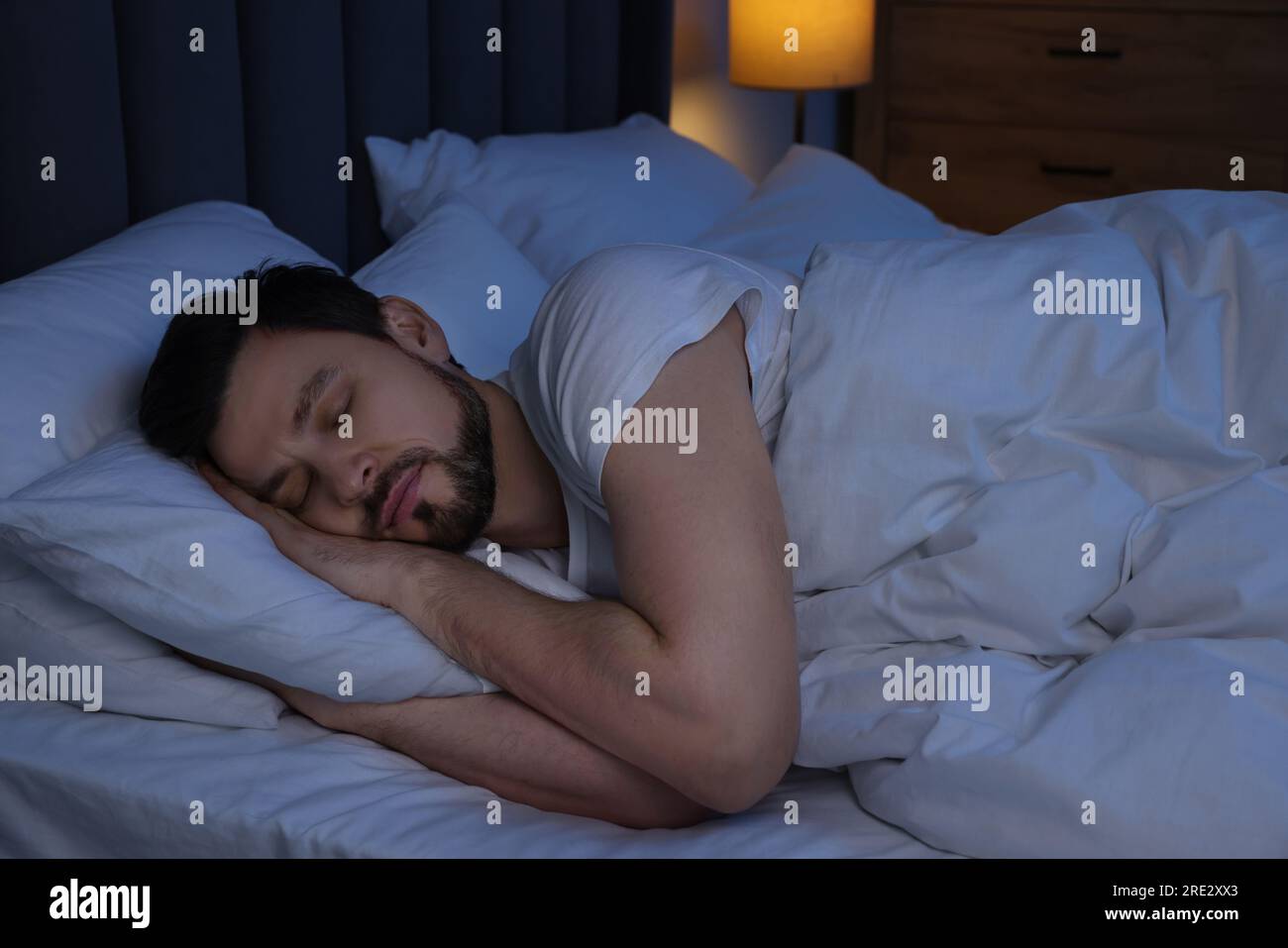 Handsome man sleeping in bed at night Stock Photo - Alamy