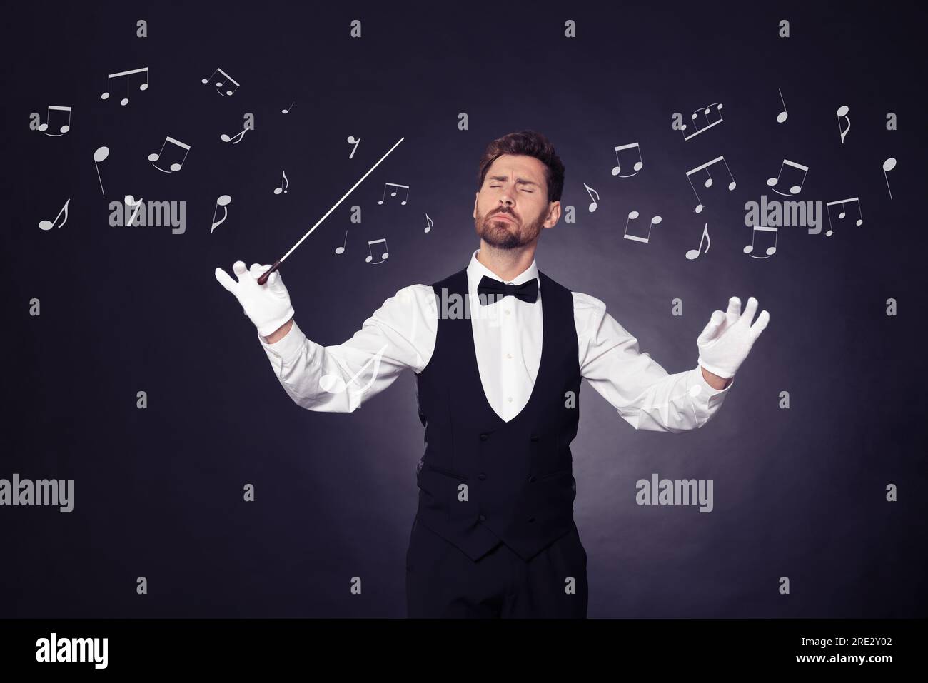 Conductor with baton and music notes on dark background Stock Photo - Alamy