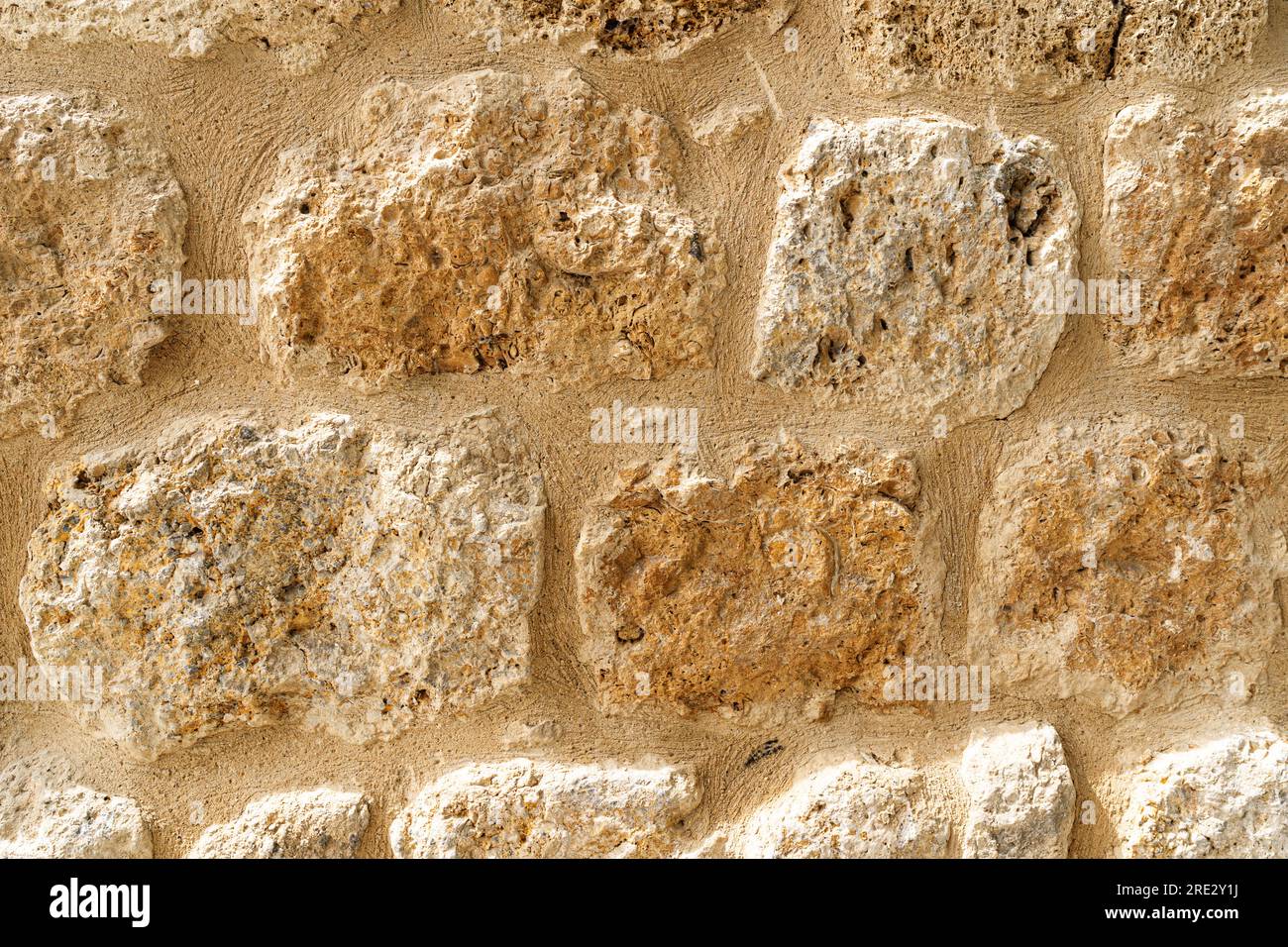 Old beige stone wall background texture close up. Castle wall surface ...