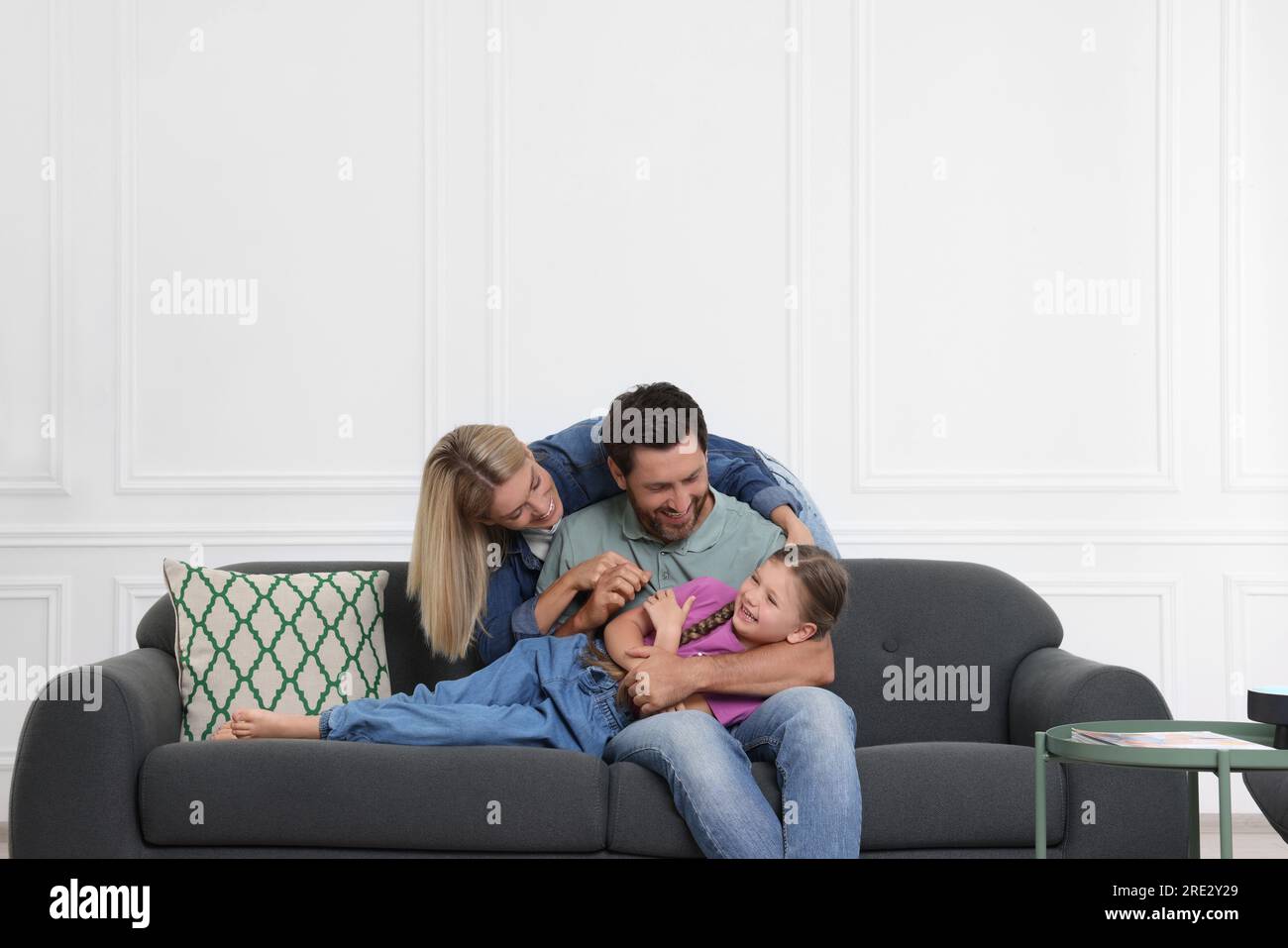 Happy family having fun together on sofa at home Stock Photo - Alamy