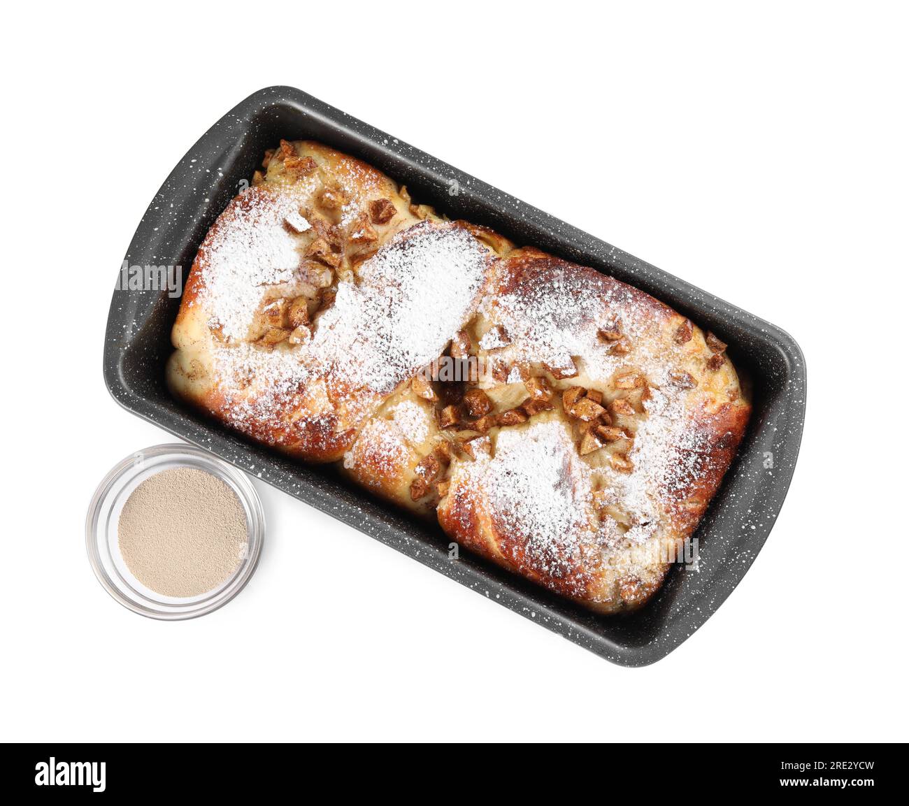 Delicious cake in baking pan and dry yeast on white background, top ...