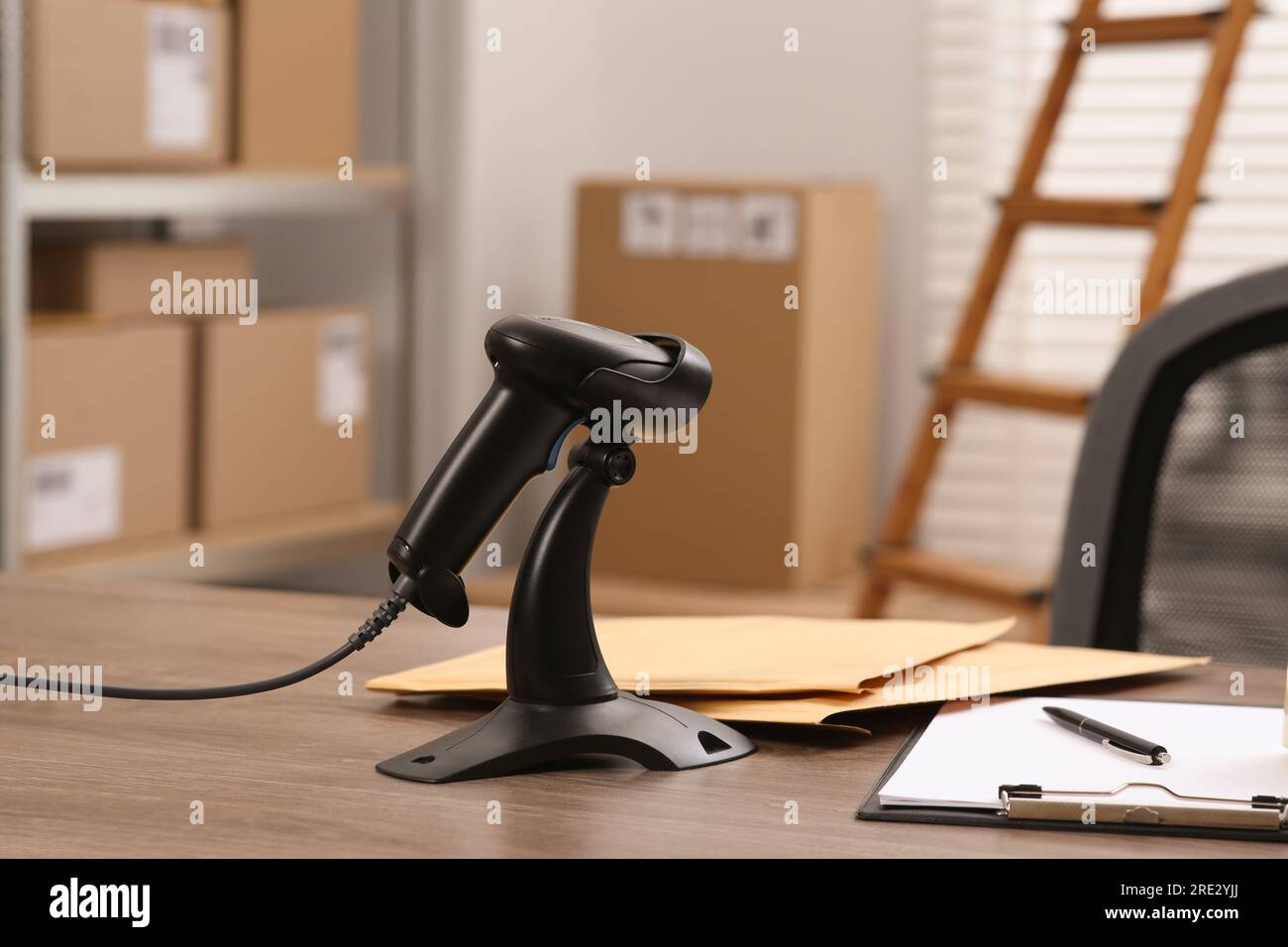 Black modern barcode scanner on wooden table in office. Online store ...