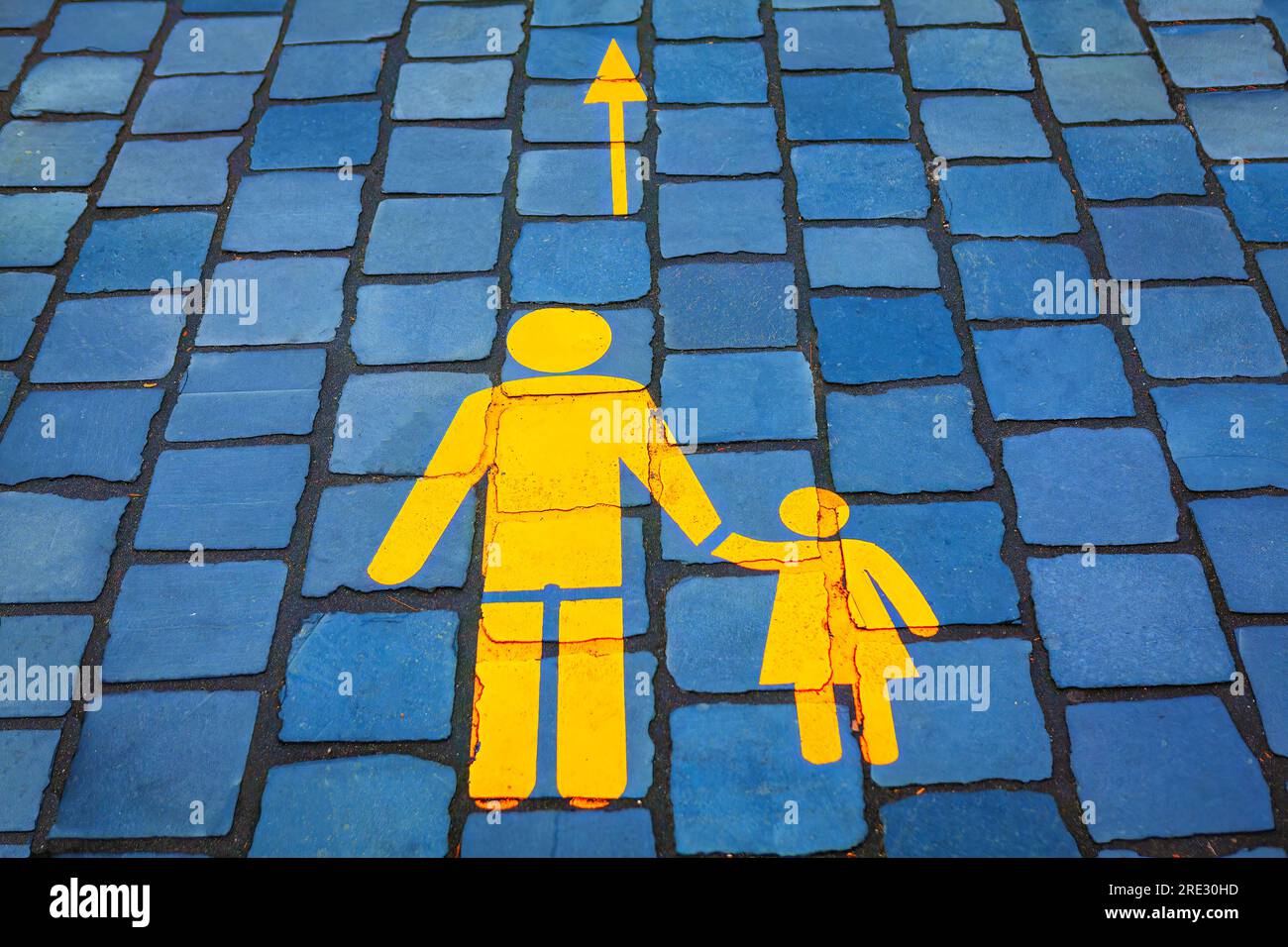 Pedestrian walkway with yellow family symbol . Yellow family painted on ...